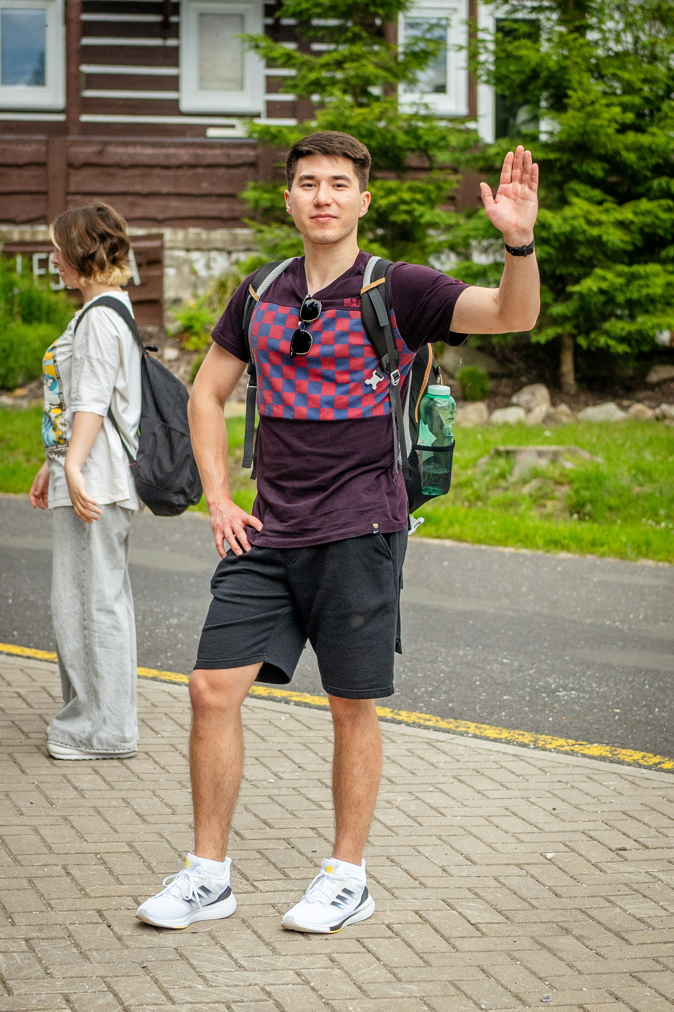 Raised hand, ready to go: a confident traveler pauses at the curb