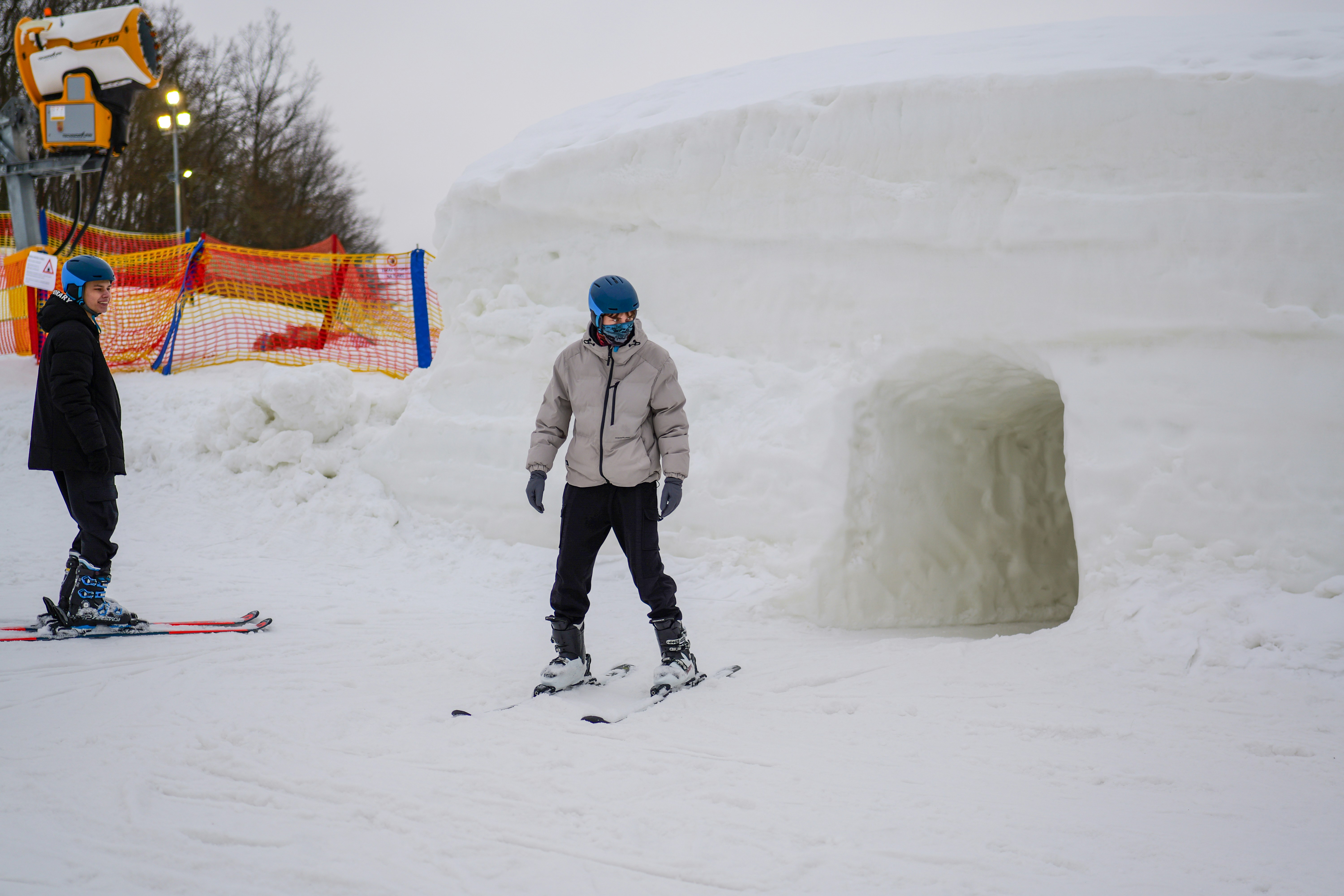 Lone Skier at the Snow-Clear Entrance to an Icy Dome