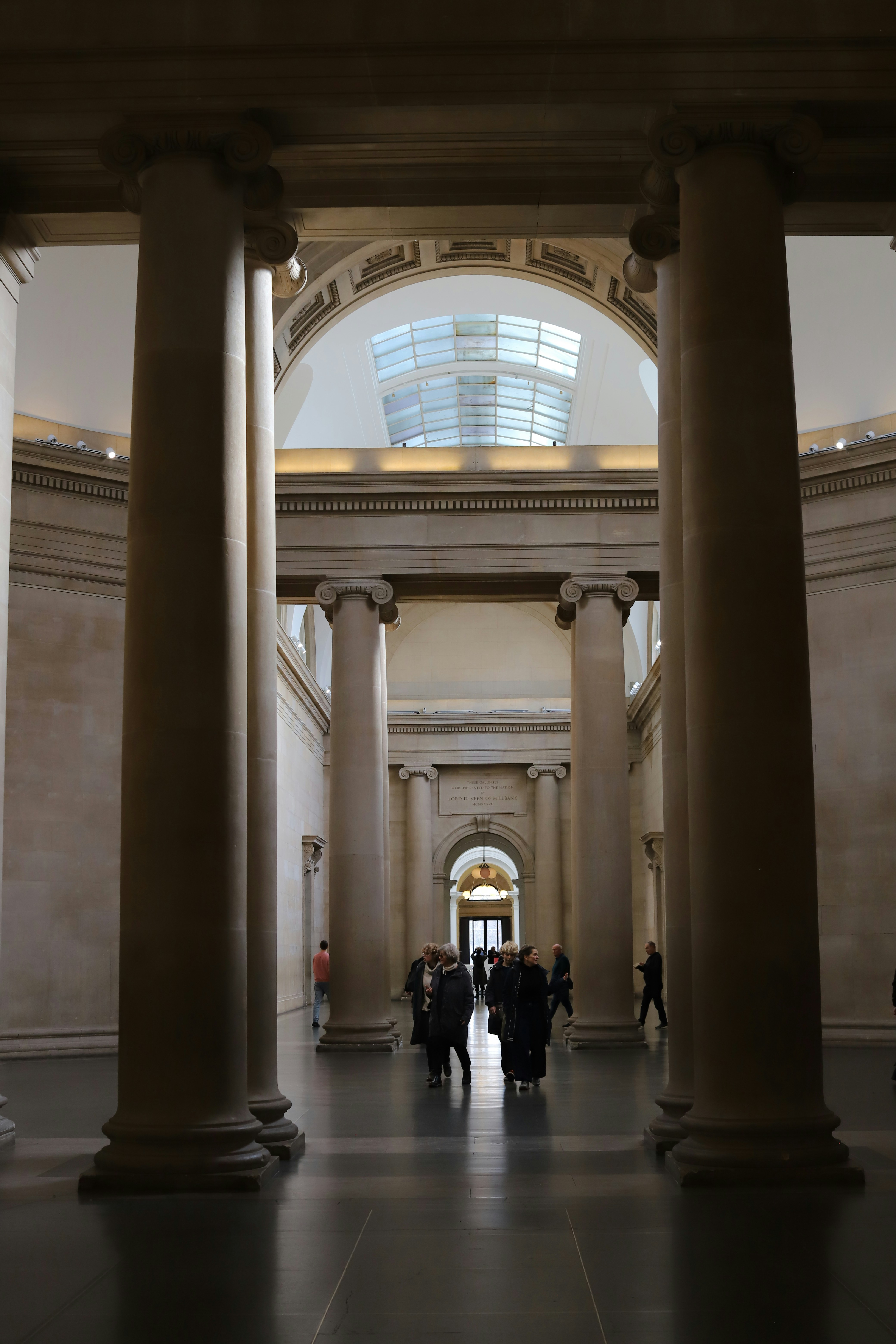 Sunlit Hall of Columns: A Quiet Convergence beneath Arch and Glass