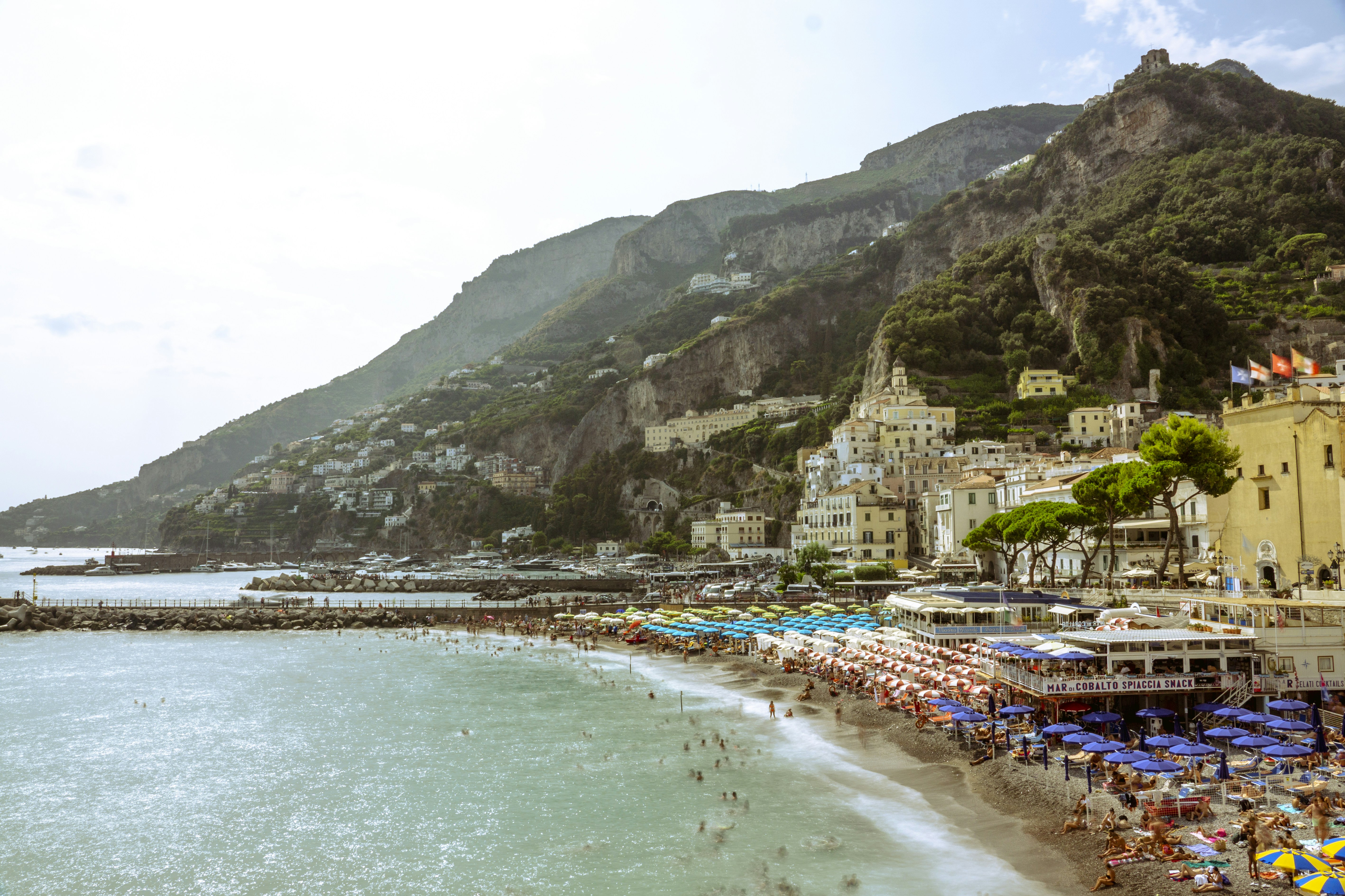 Sunlit Adriatic Shoreline: Terraced Village Clinging to the Rocks