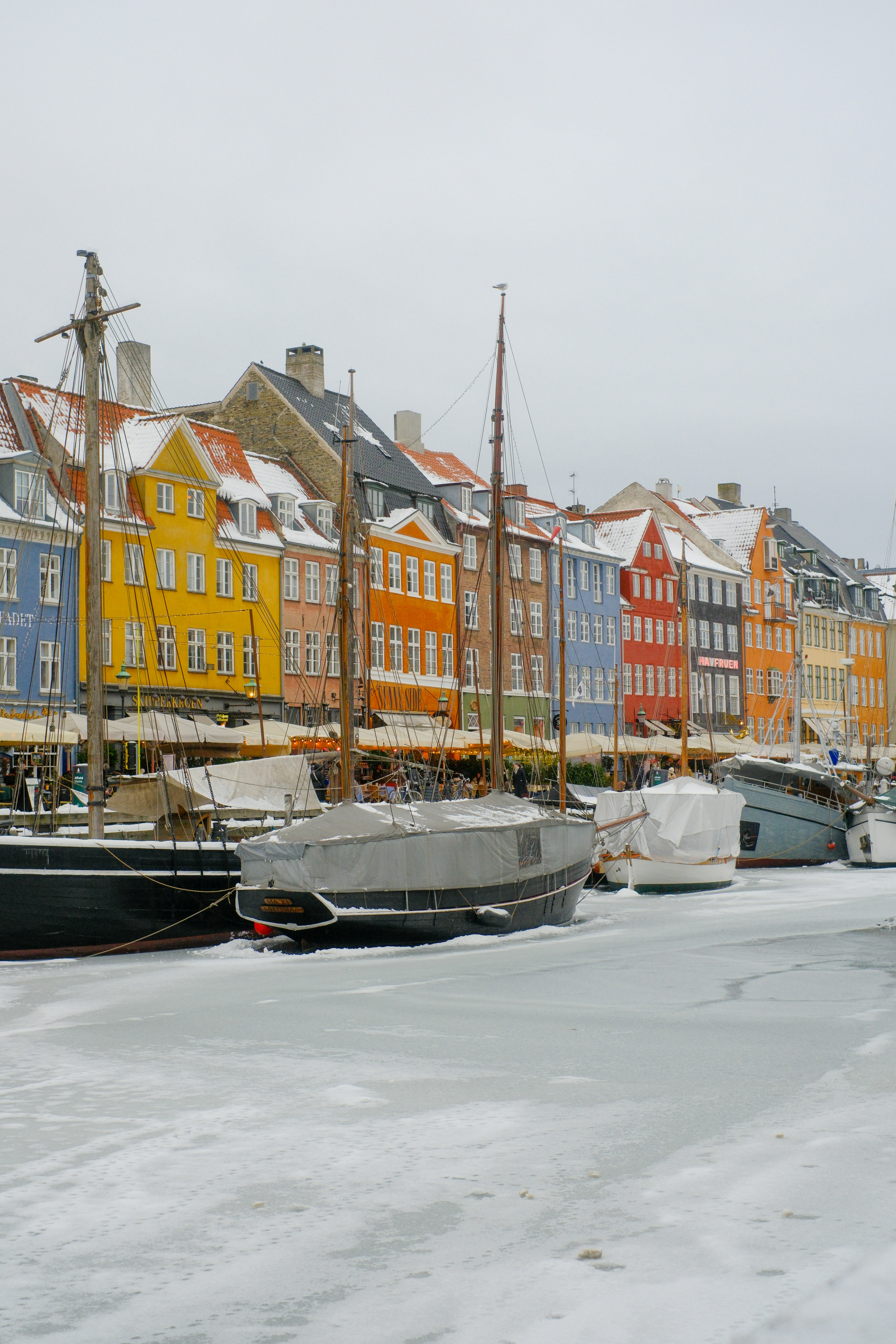Colorful Rowboats and Harbor Townfront in Winter Light
