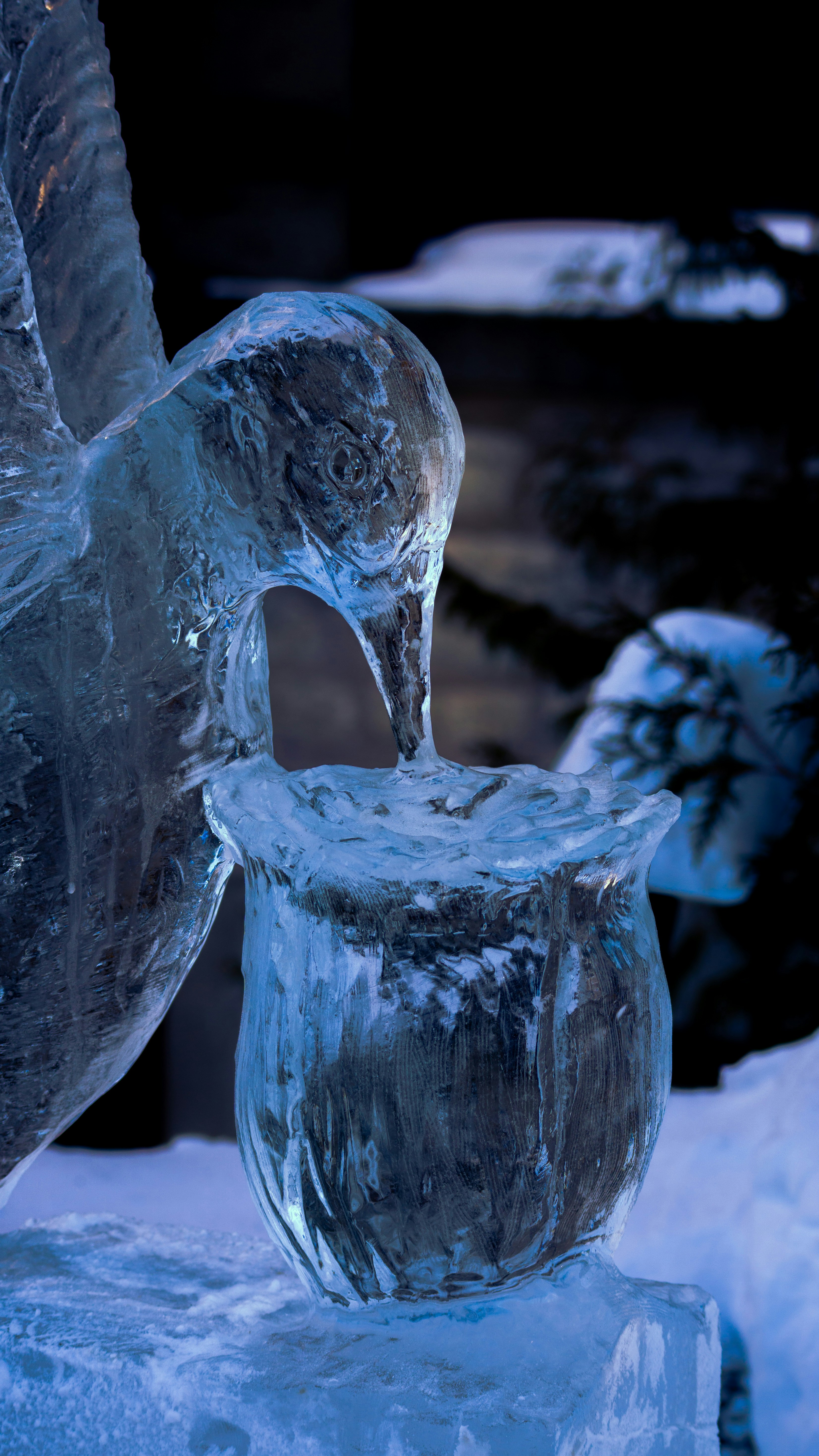 Ice Crane Pouring Light: A Blue-Hued Sculpture in Winter Night
