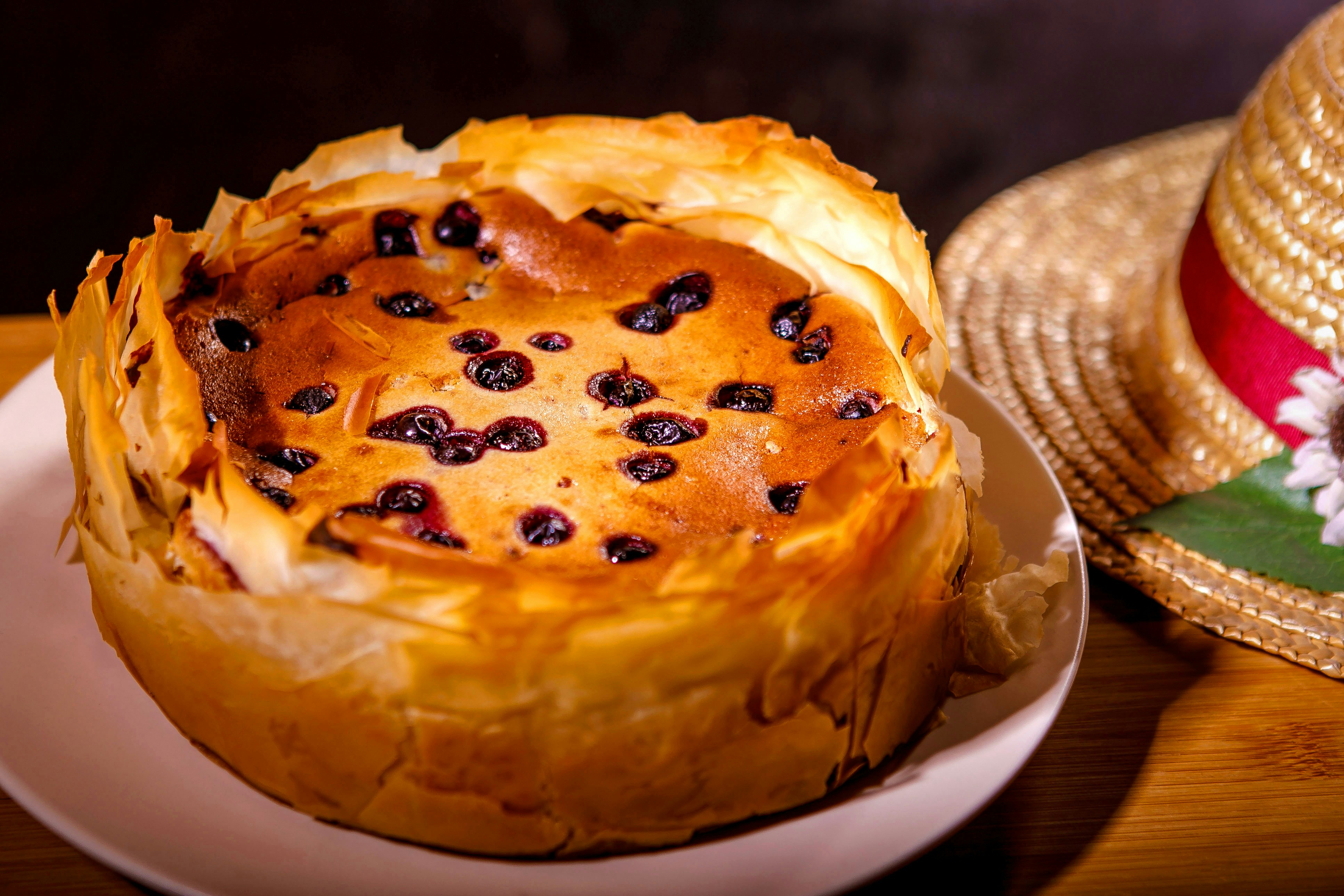 Golden Crowned Berry Cheesecake on a Rustic Plate