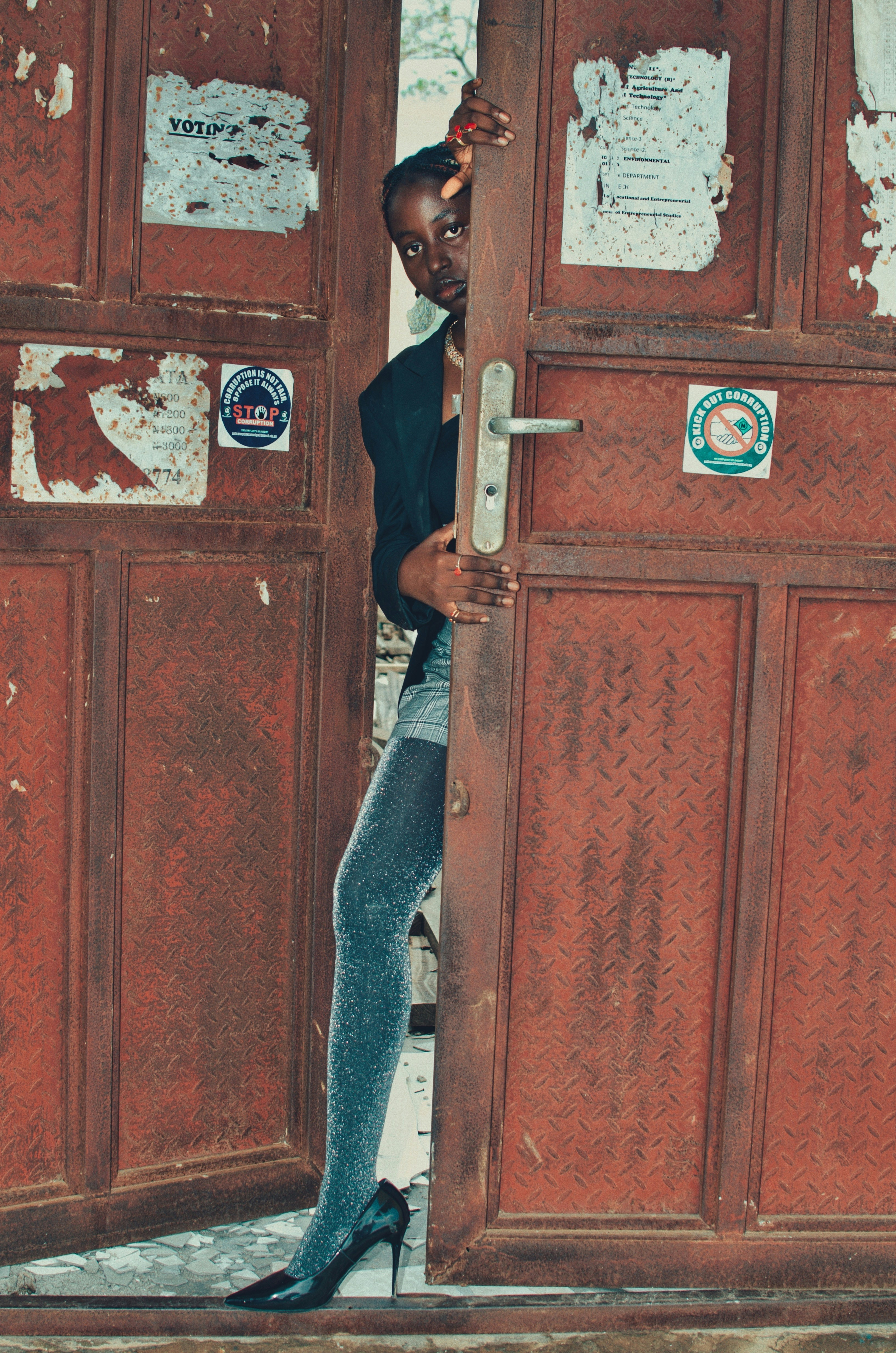 Hidden Entrance: Portrait at the Edge of a Rusted Doorway