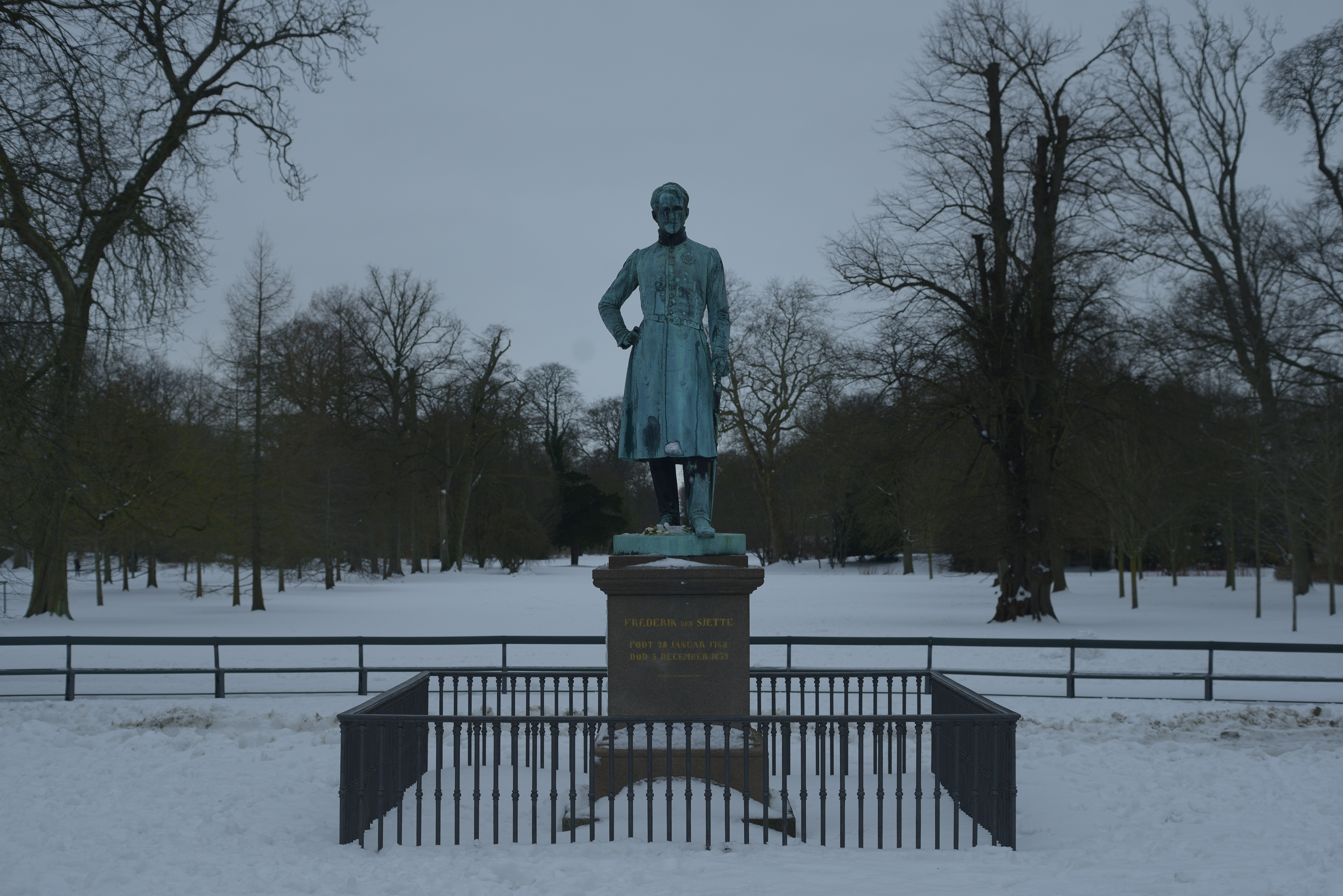 Bronze Leader in Winter: A statue Reaching Skyward
