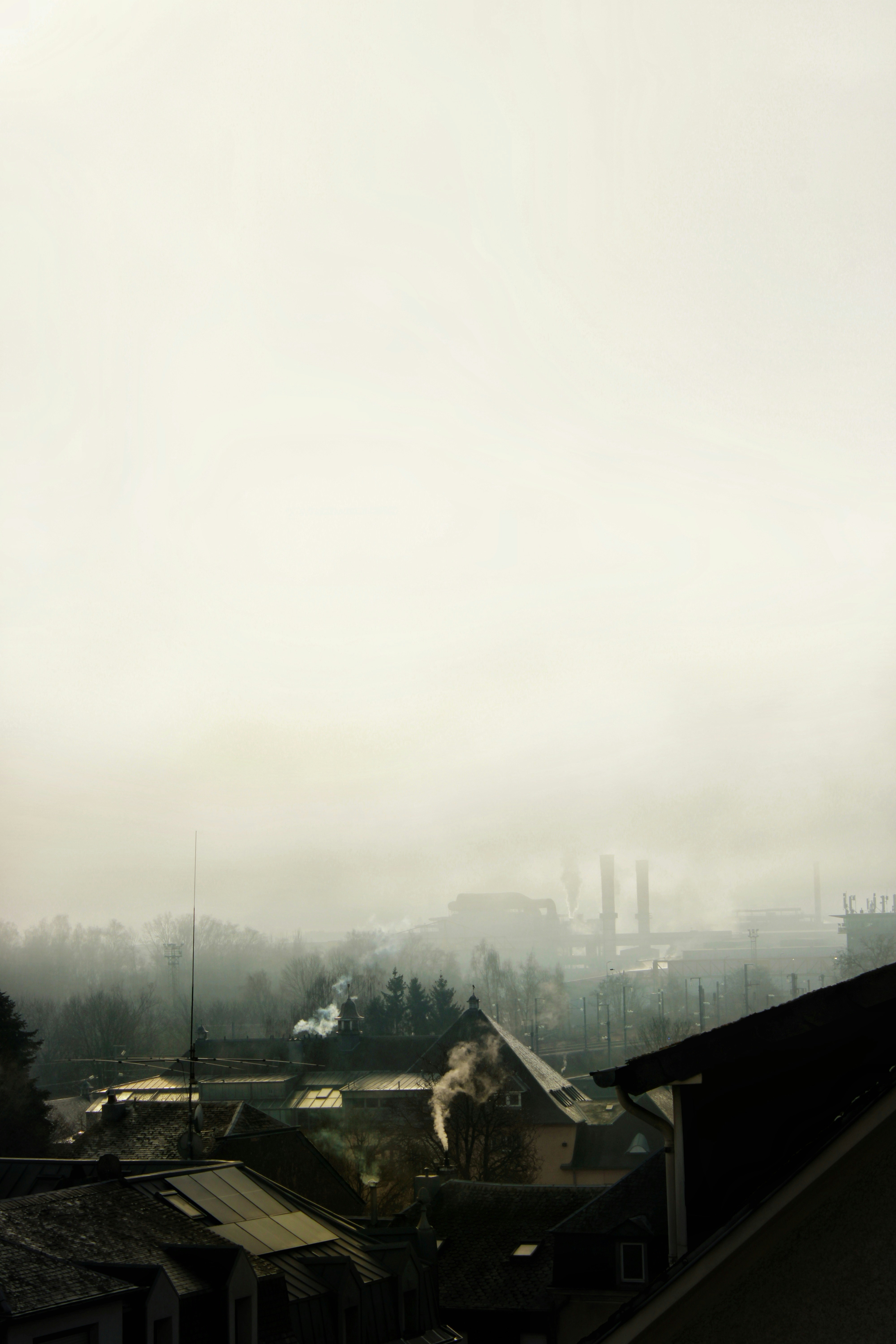 Industrial Mist Over Quiet Rooftops at Dusk
