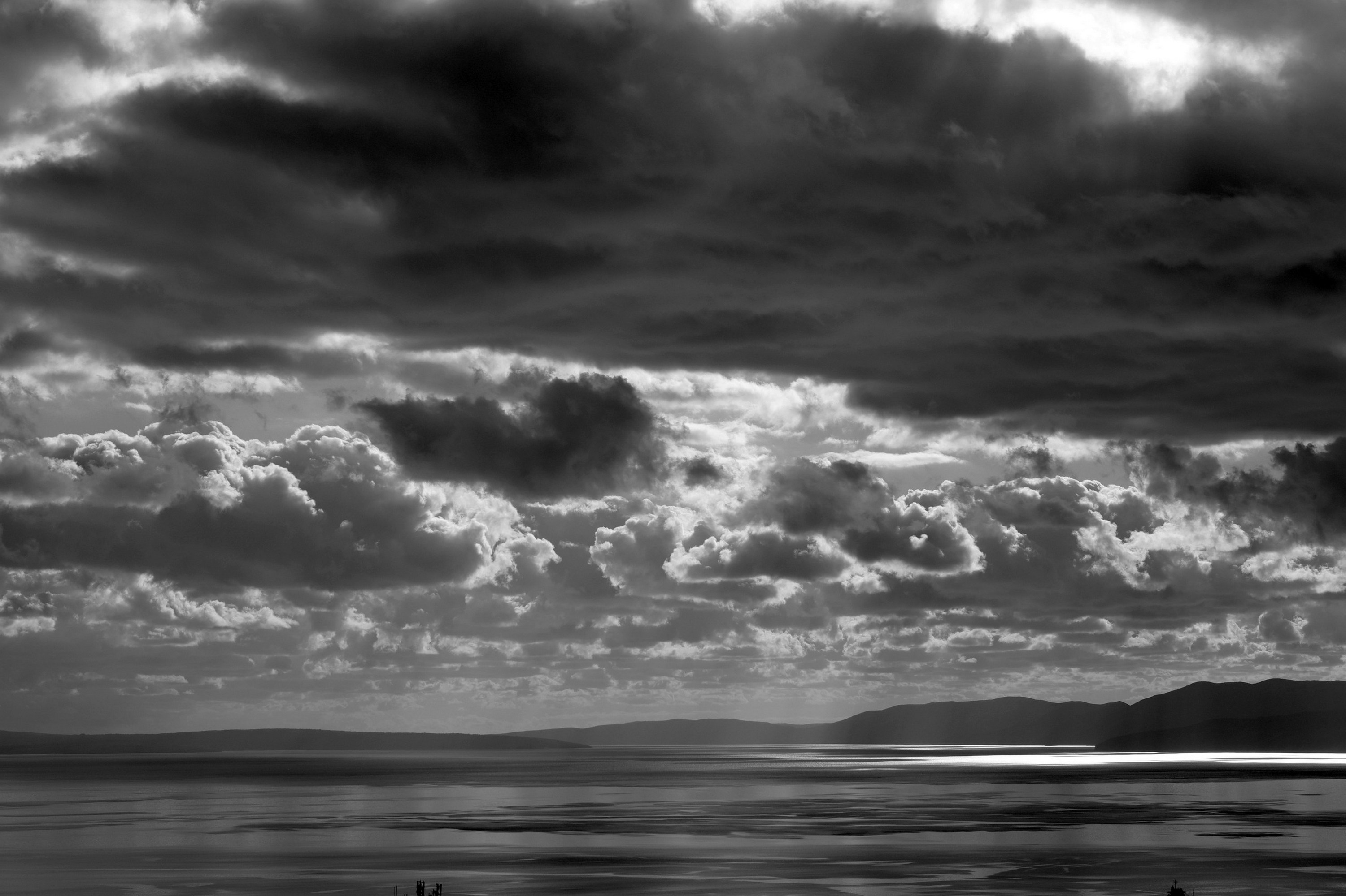Clouds Over Quiet Water: A Monochrome Horizon