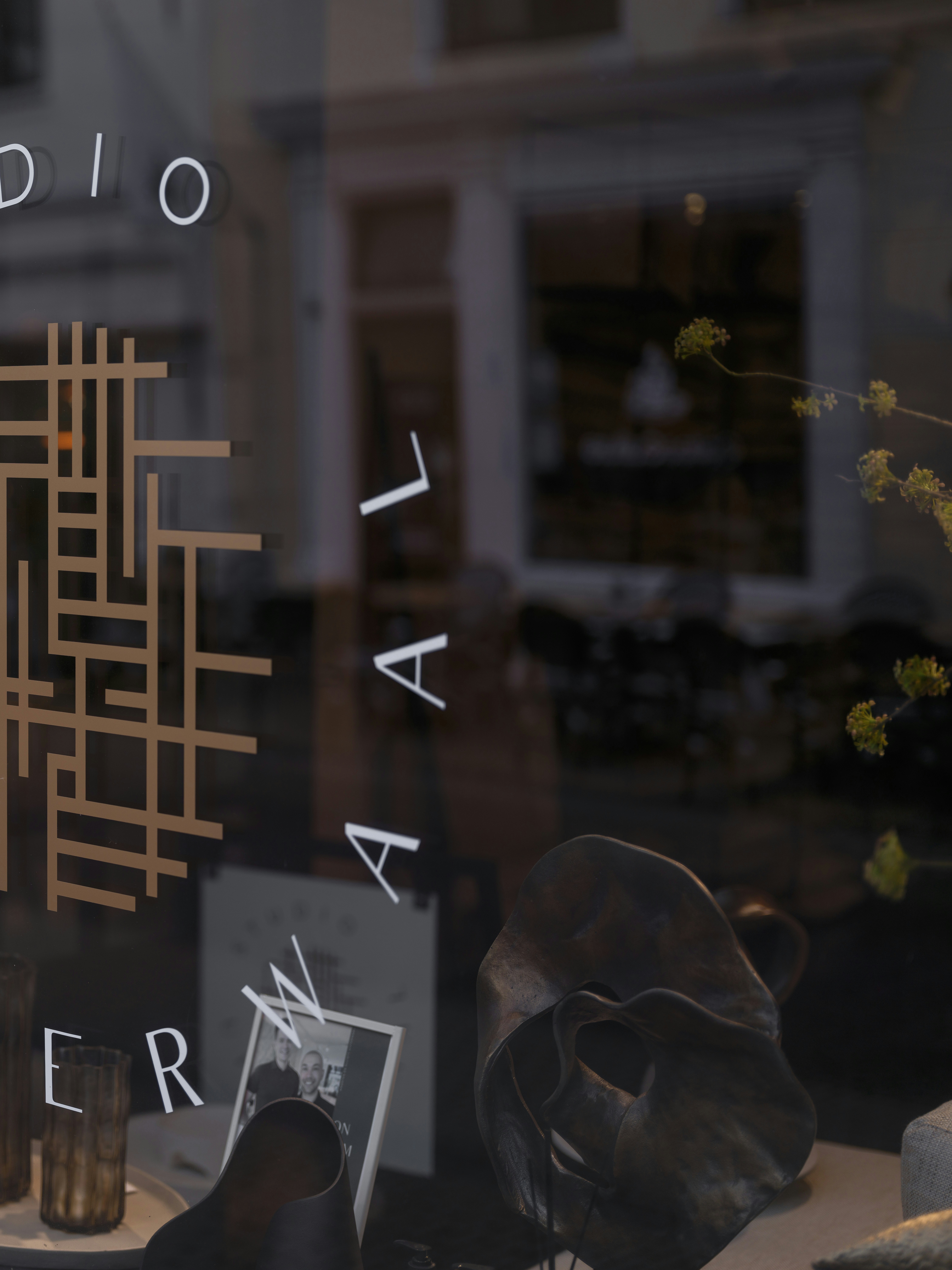 Reflected Shop Window with Glass Letters and Interior Silhouettes