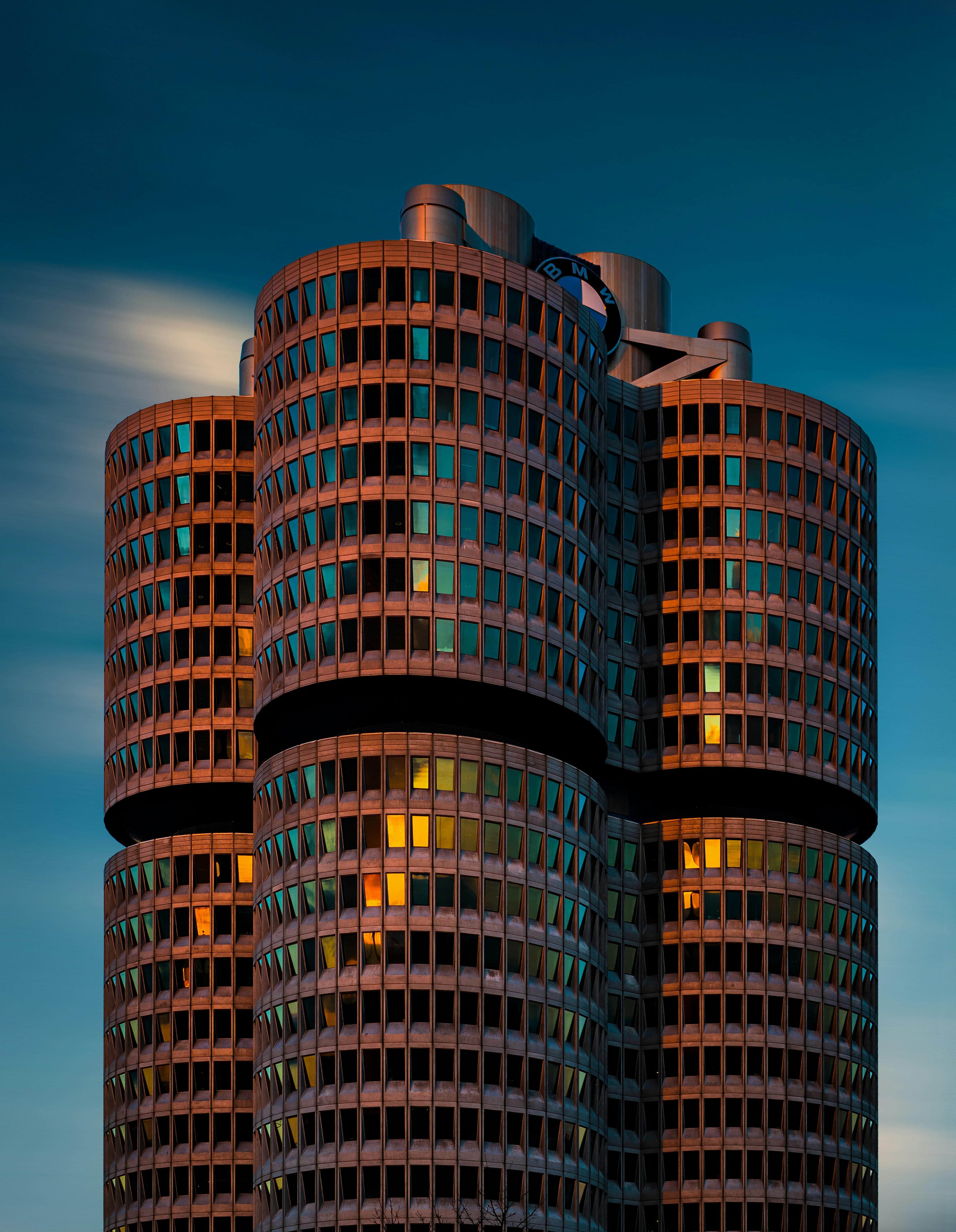 Cylindrical Giants: A trio of stacked towers catching sunset hues