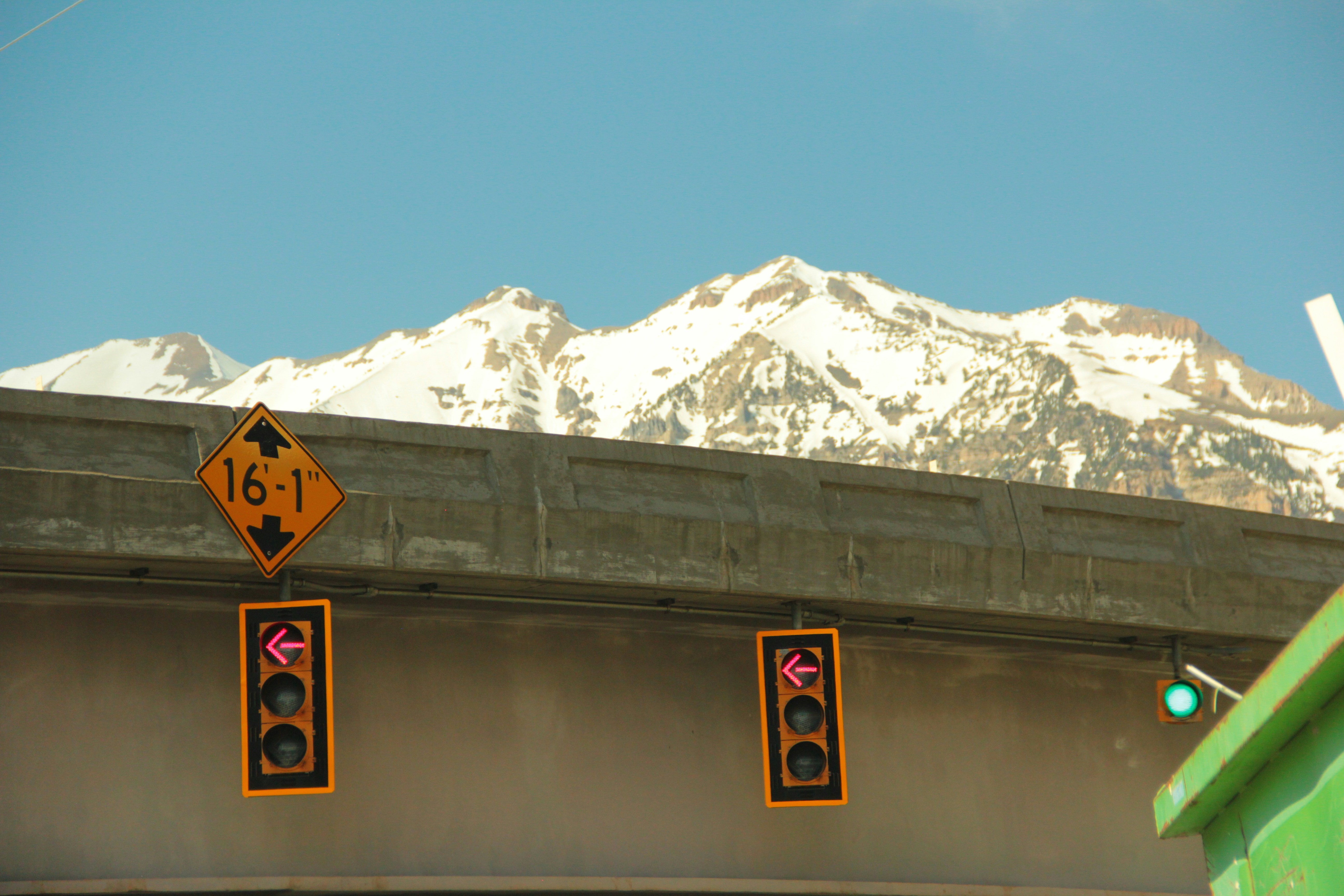 Snow-capped Peaks above a Busy Urban Overpass