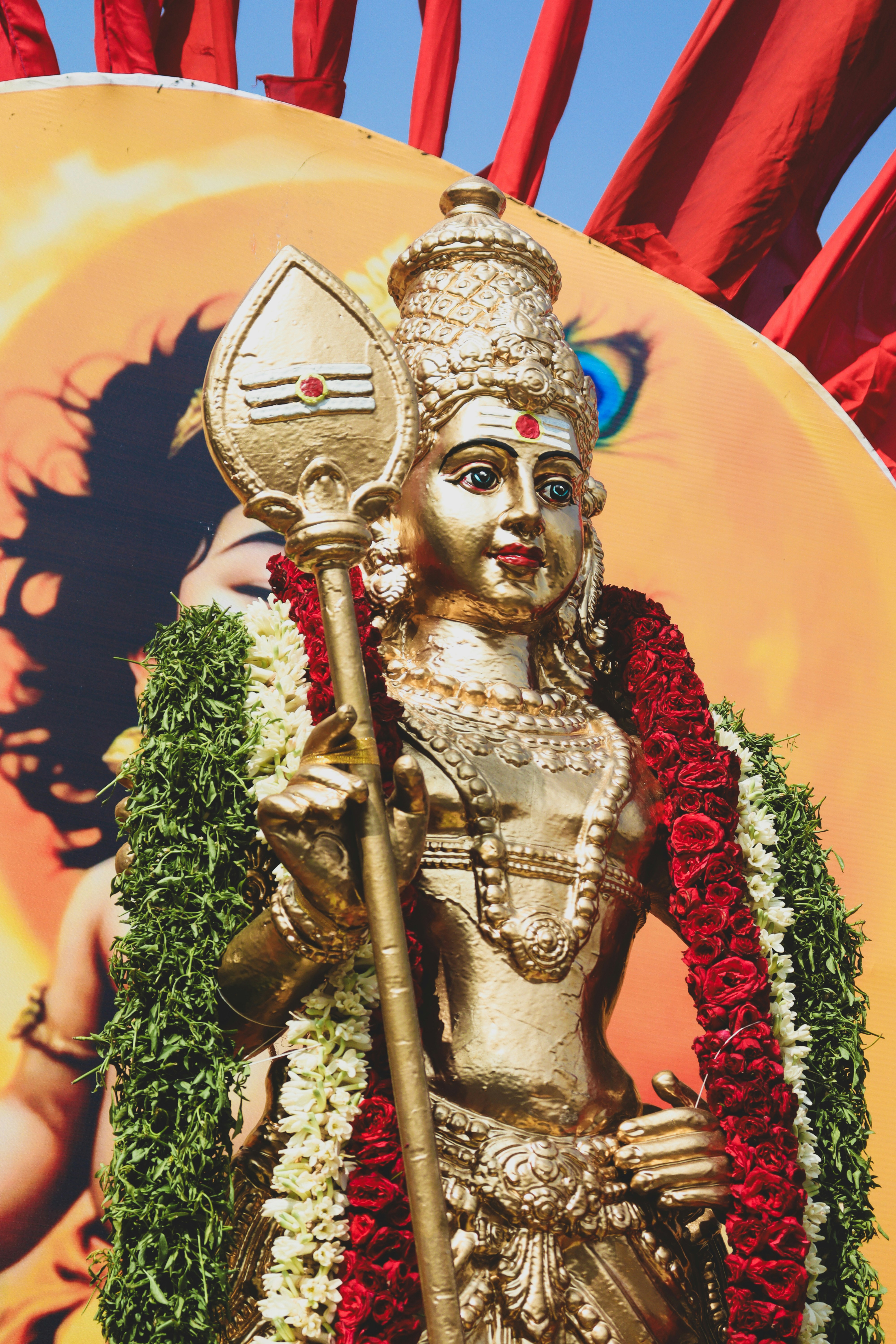Golden Statue in Festive Adornment: A Divine Portrait with Garlands