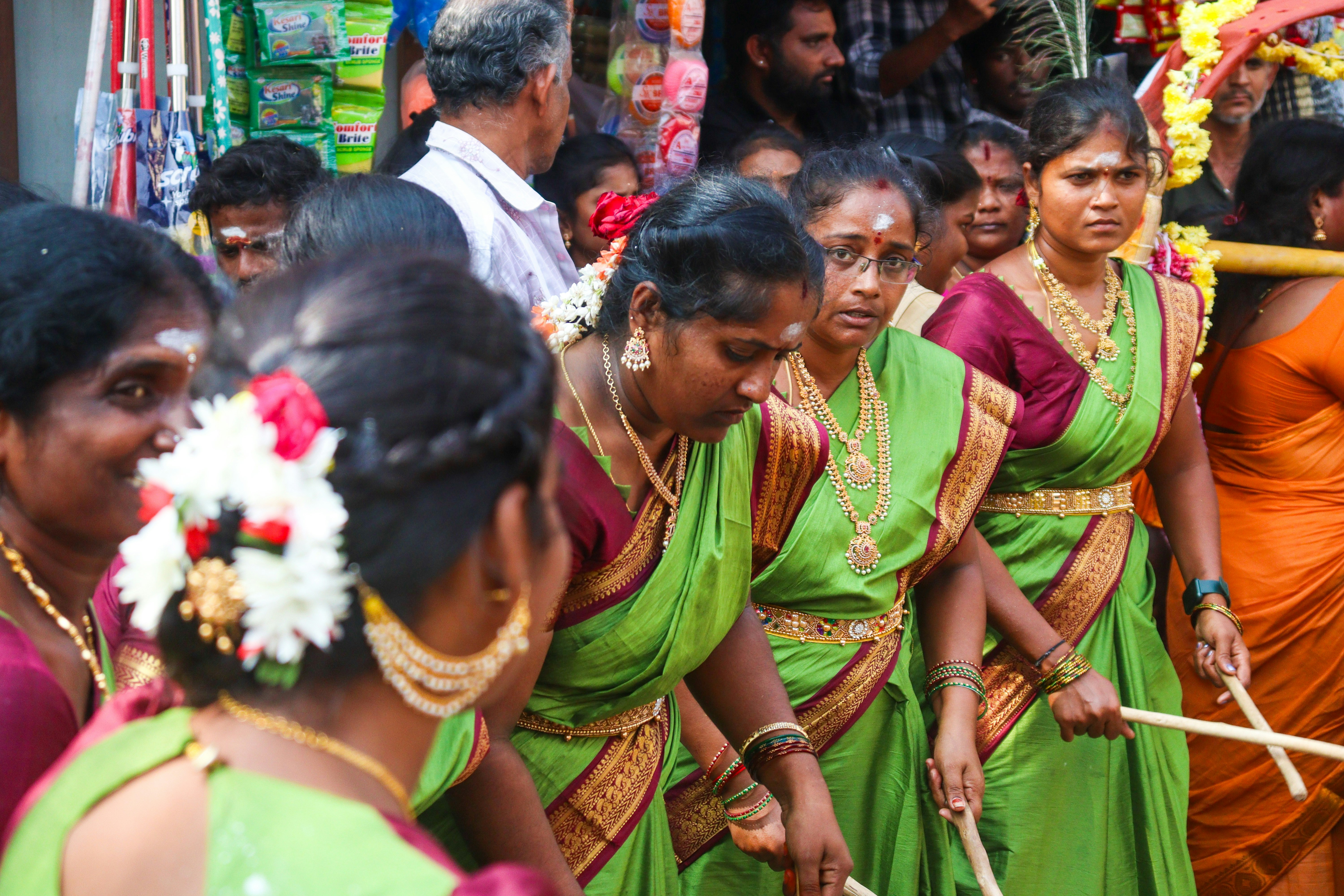 Green Sari Chorus: A Dancers' Moment in a Busy Market