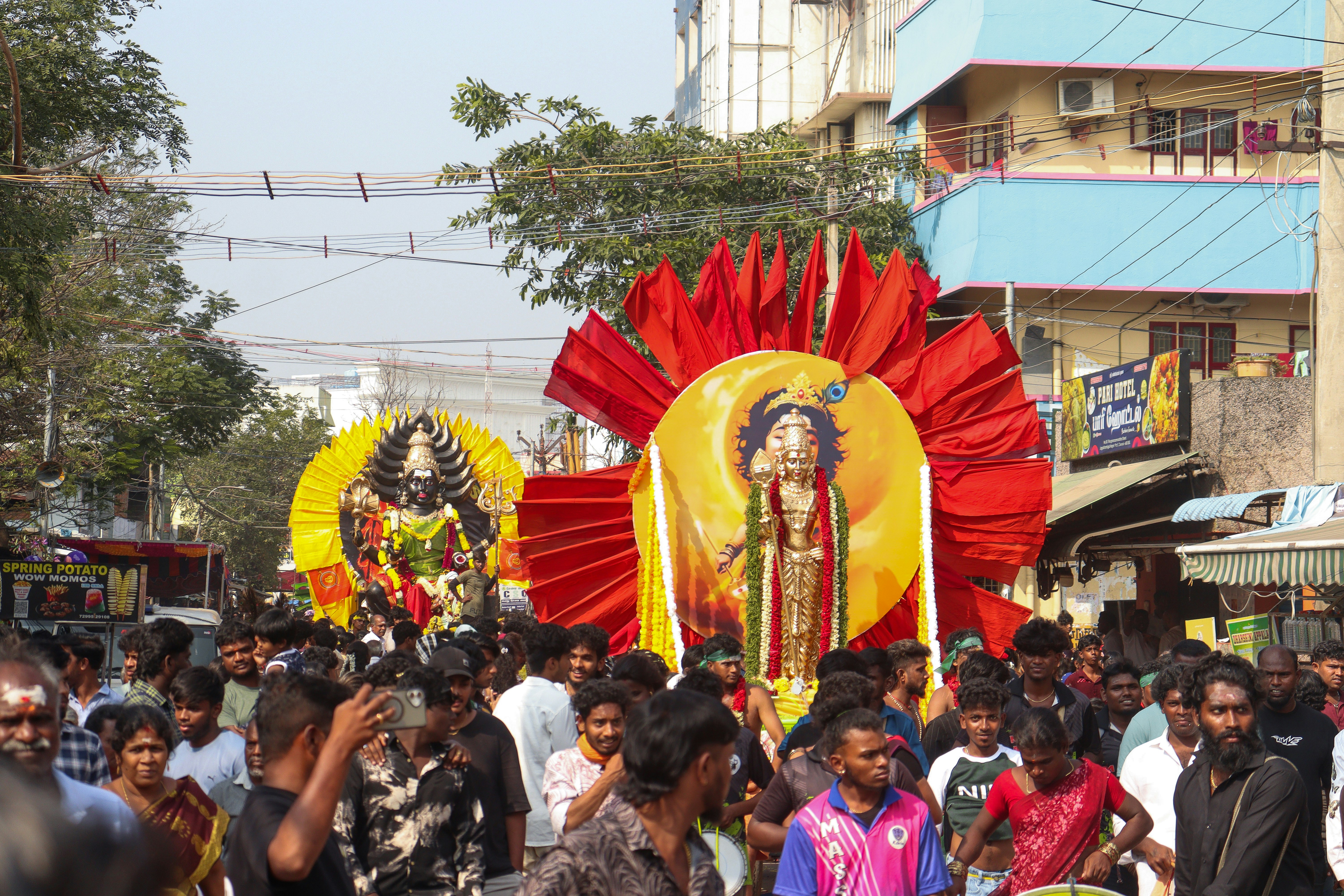 Vibrant Procession under Regal Deities