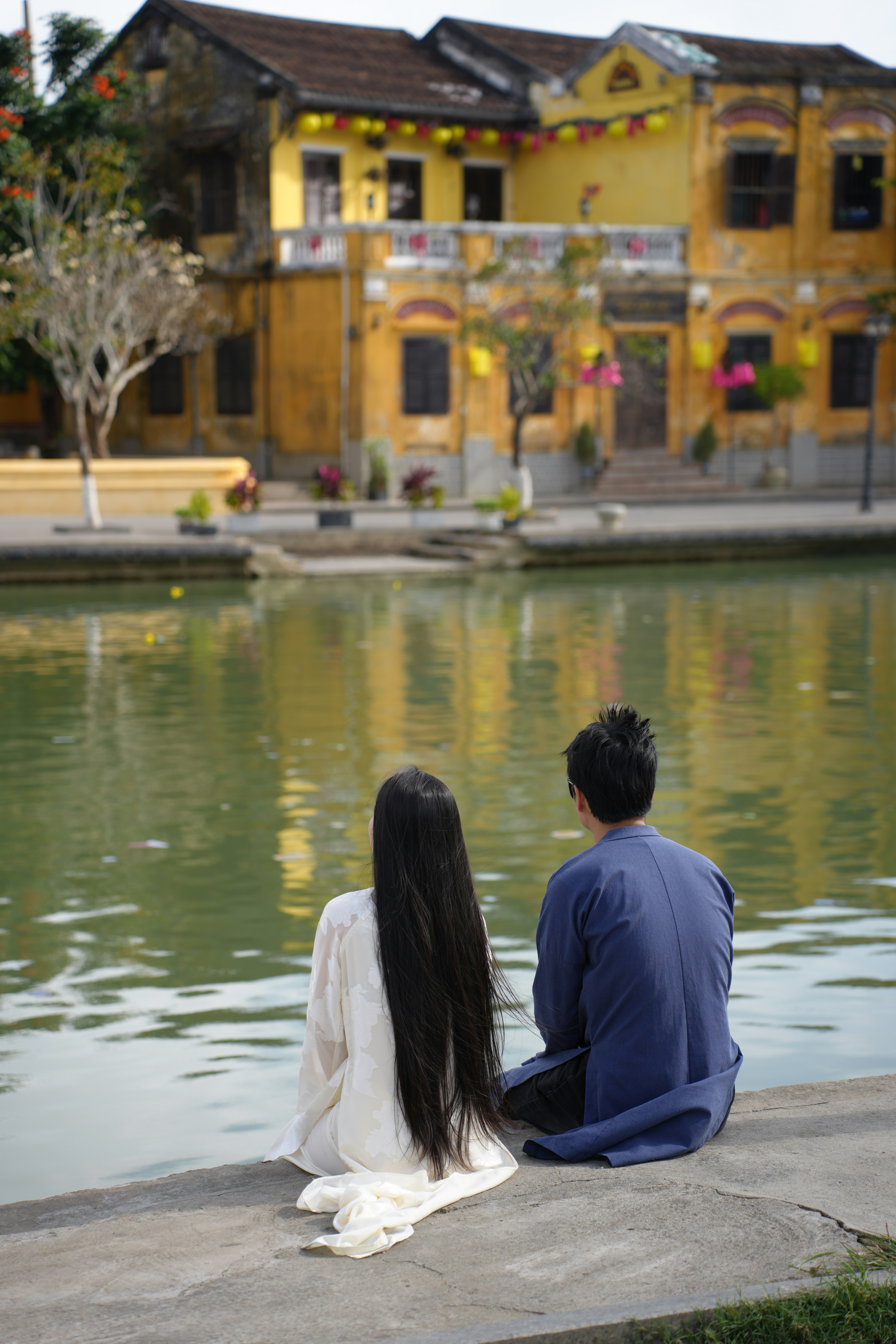 Two Silhouettes by the Riverside: Quiet Moment Before the Town