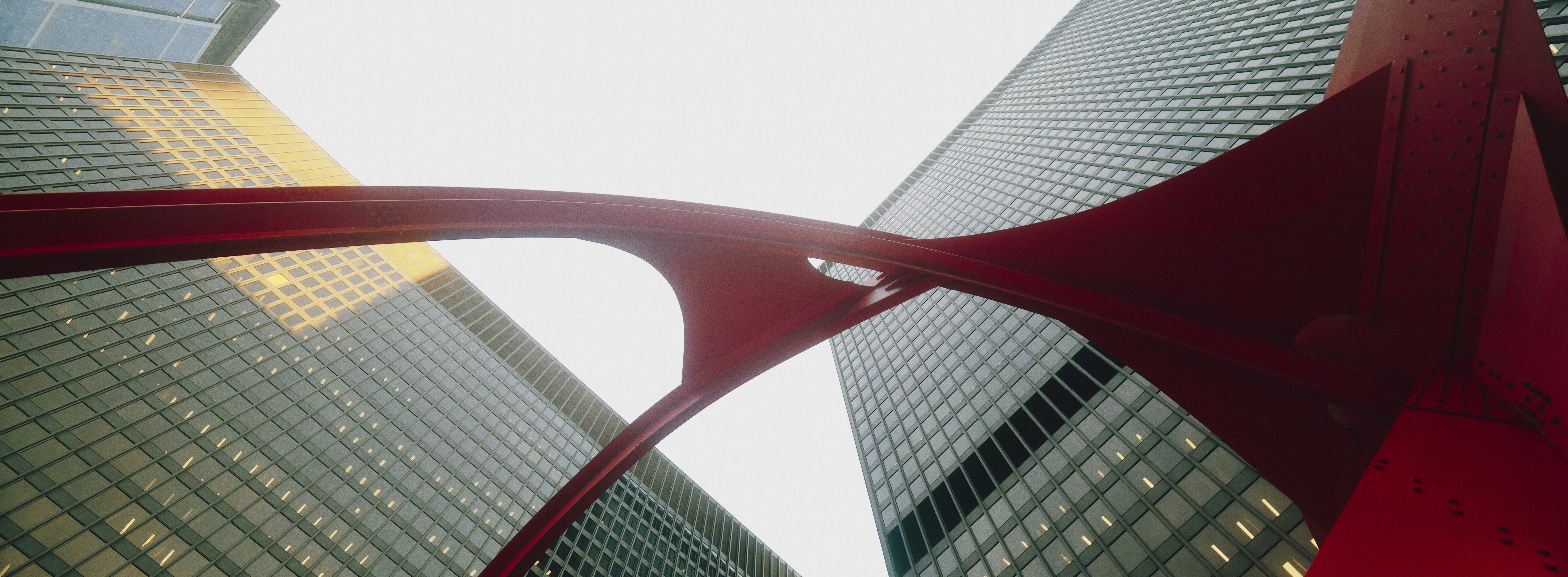 Red Architectural Arc Framing Skyscrapers