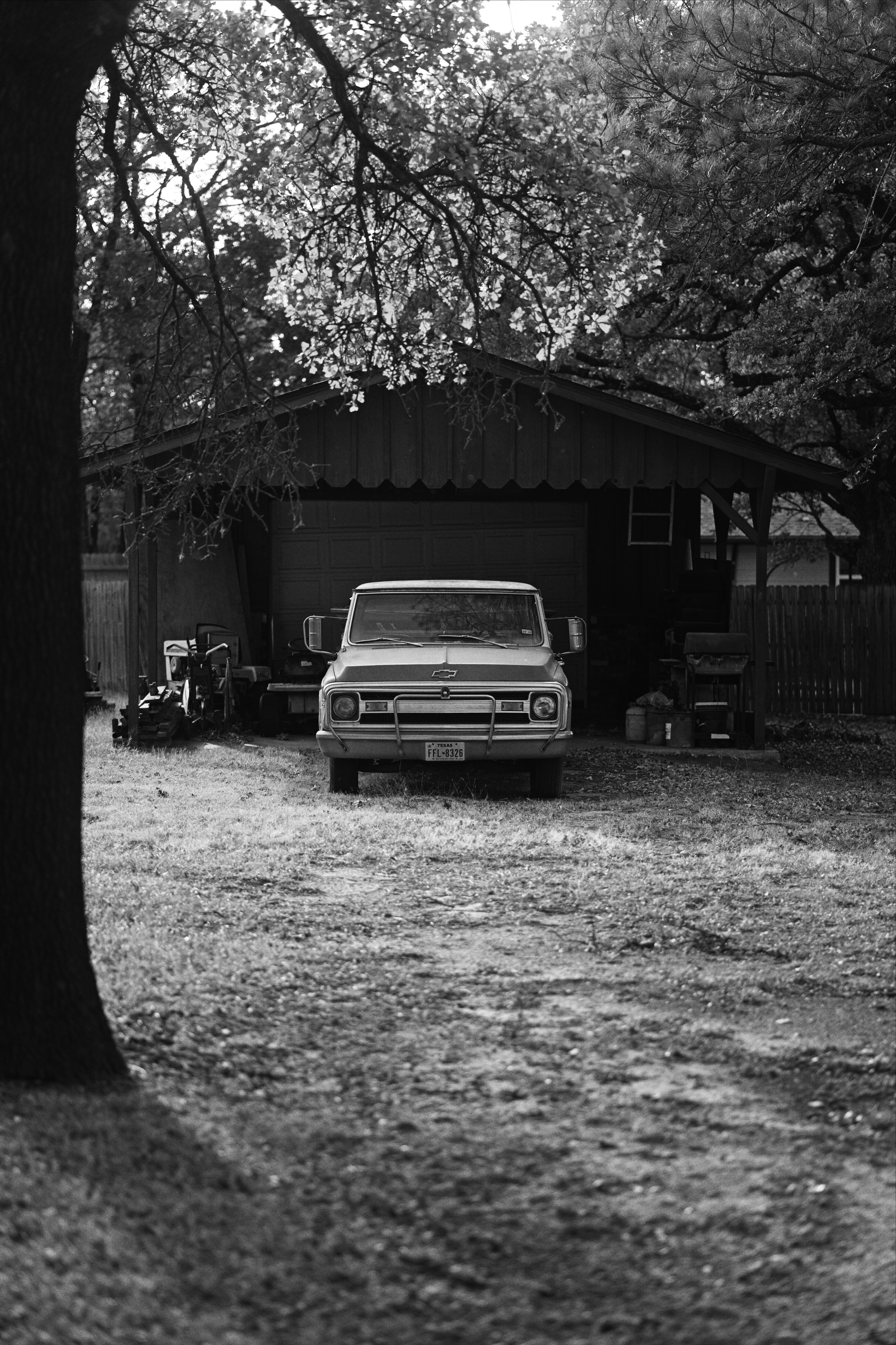 Dusty Driveway Ghost: A Classic Pickup Beckons Under Dappled Shade