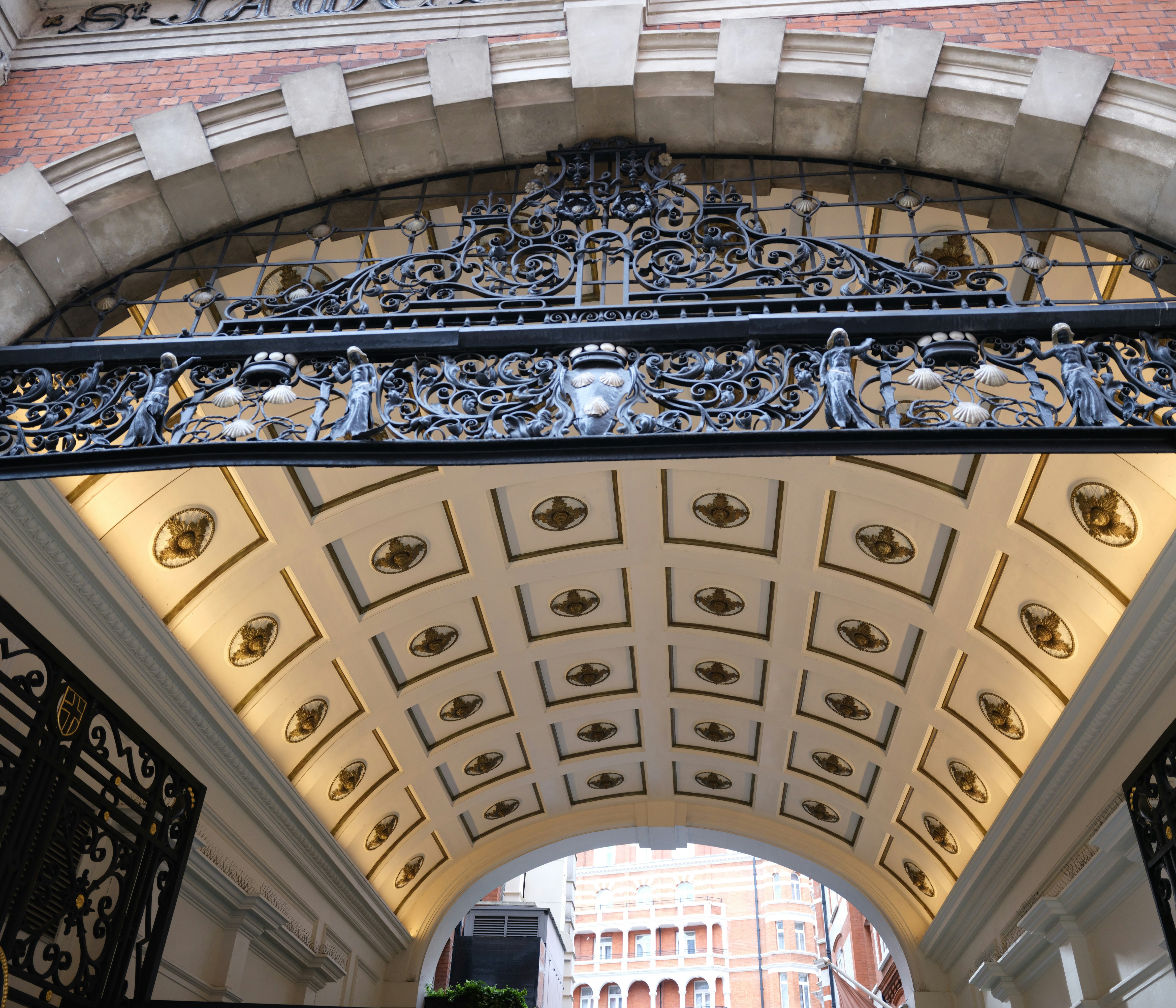 Ornate Archway Overlook: Ironwork and Vaulted Ceiling Scene