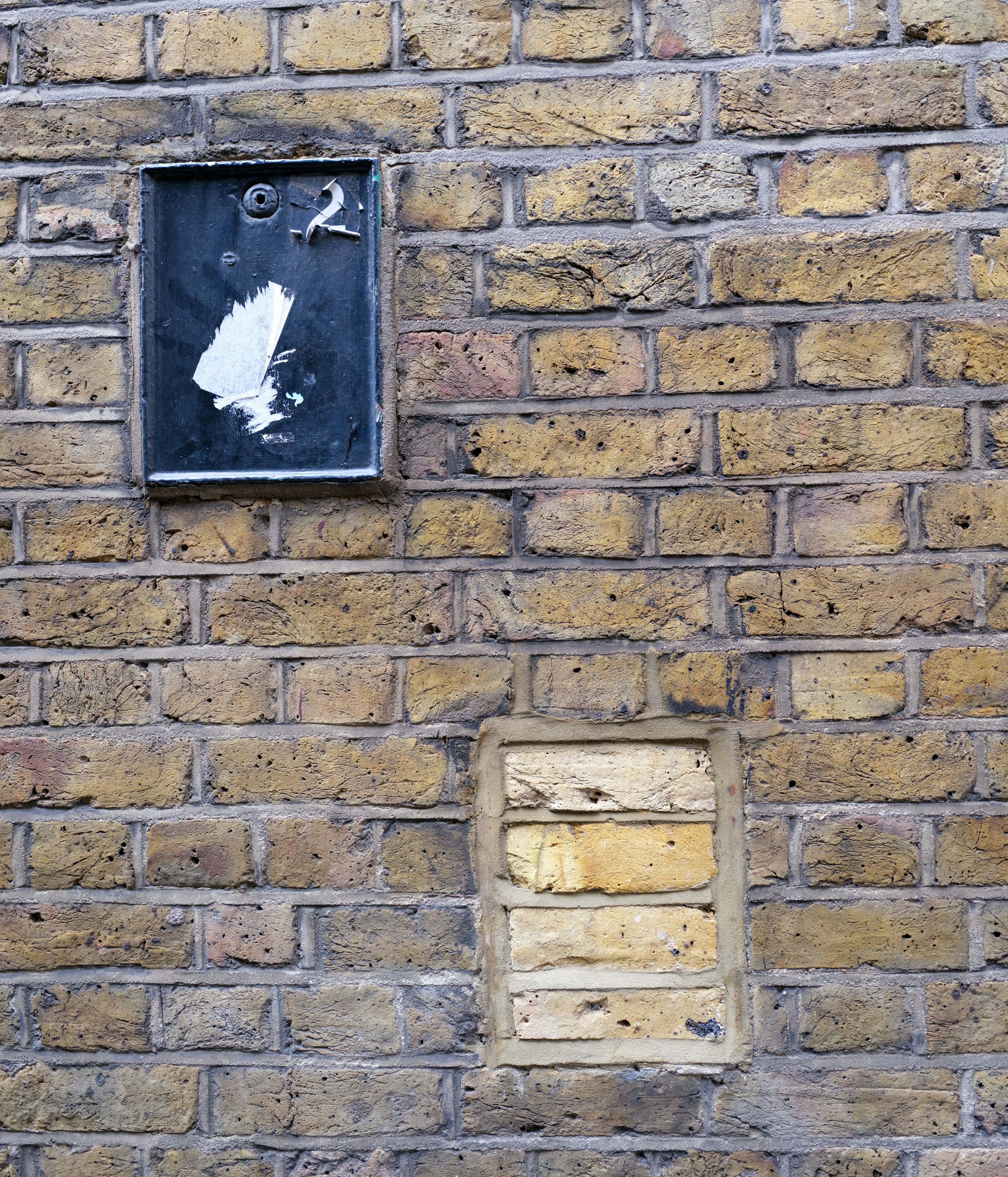 Weathered Brick Wall with Metal Mailbox and Recessed Niche