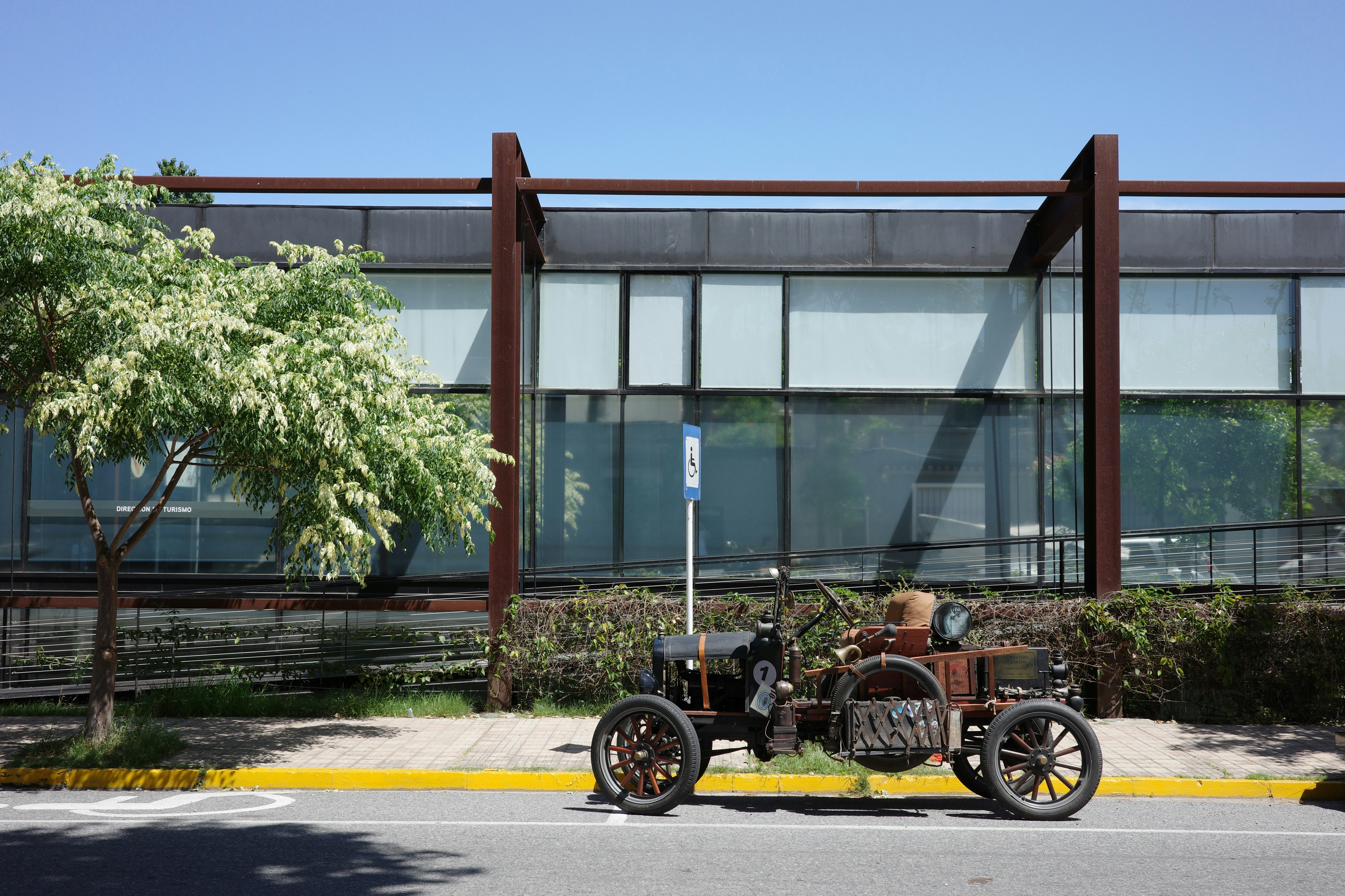 Vintage Car by Modern Glass: A Quiet Street Portrait