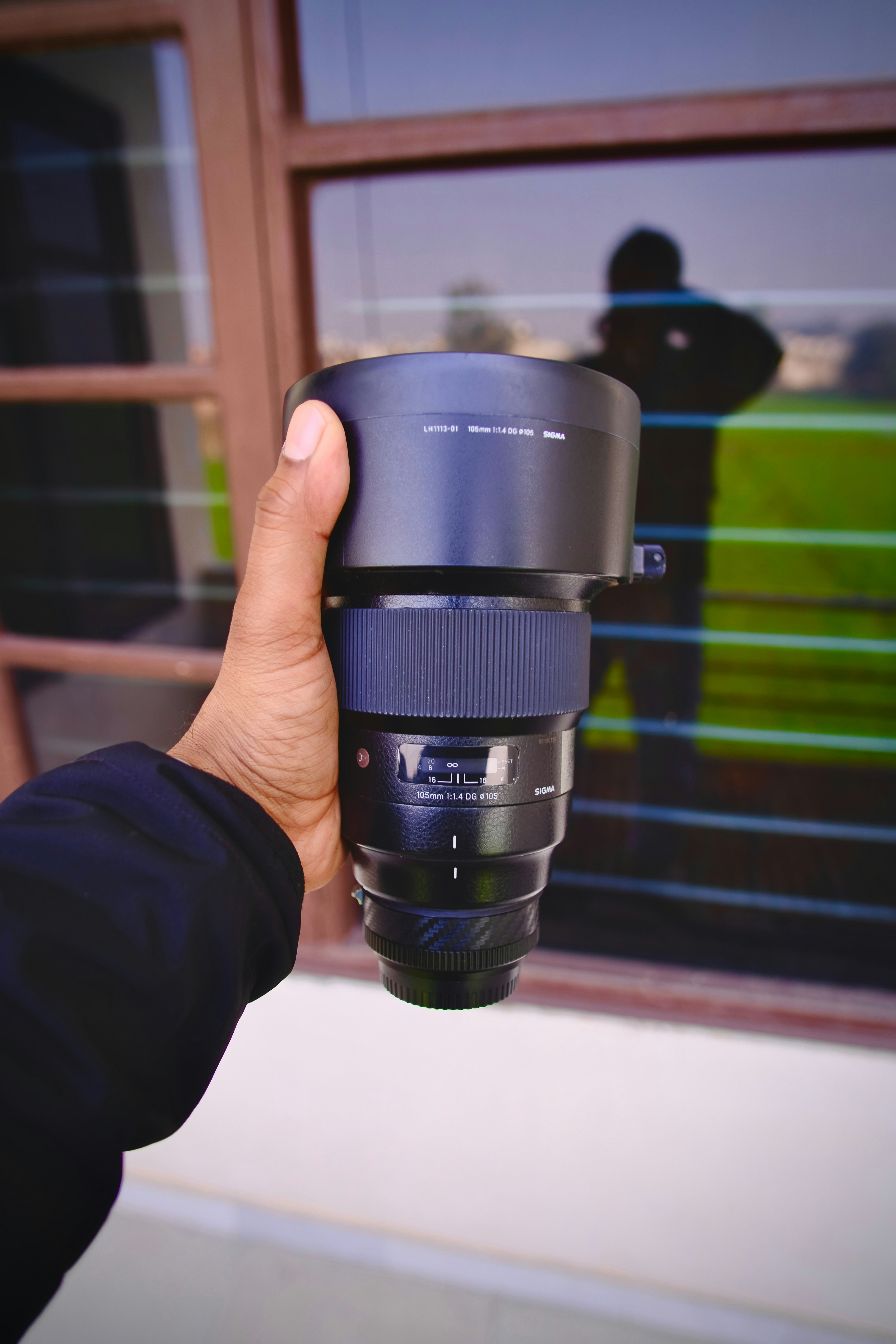 Lens in Hand: A Close-Up of a Photographer’s Grip
