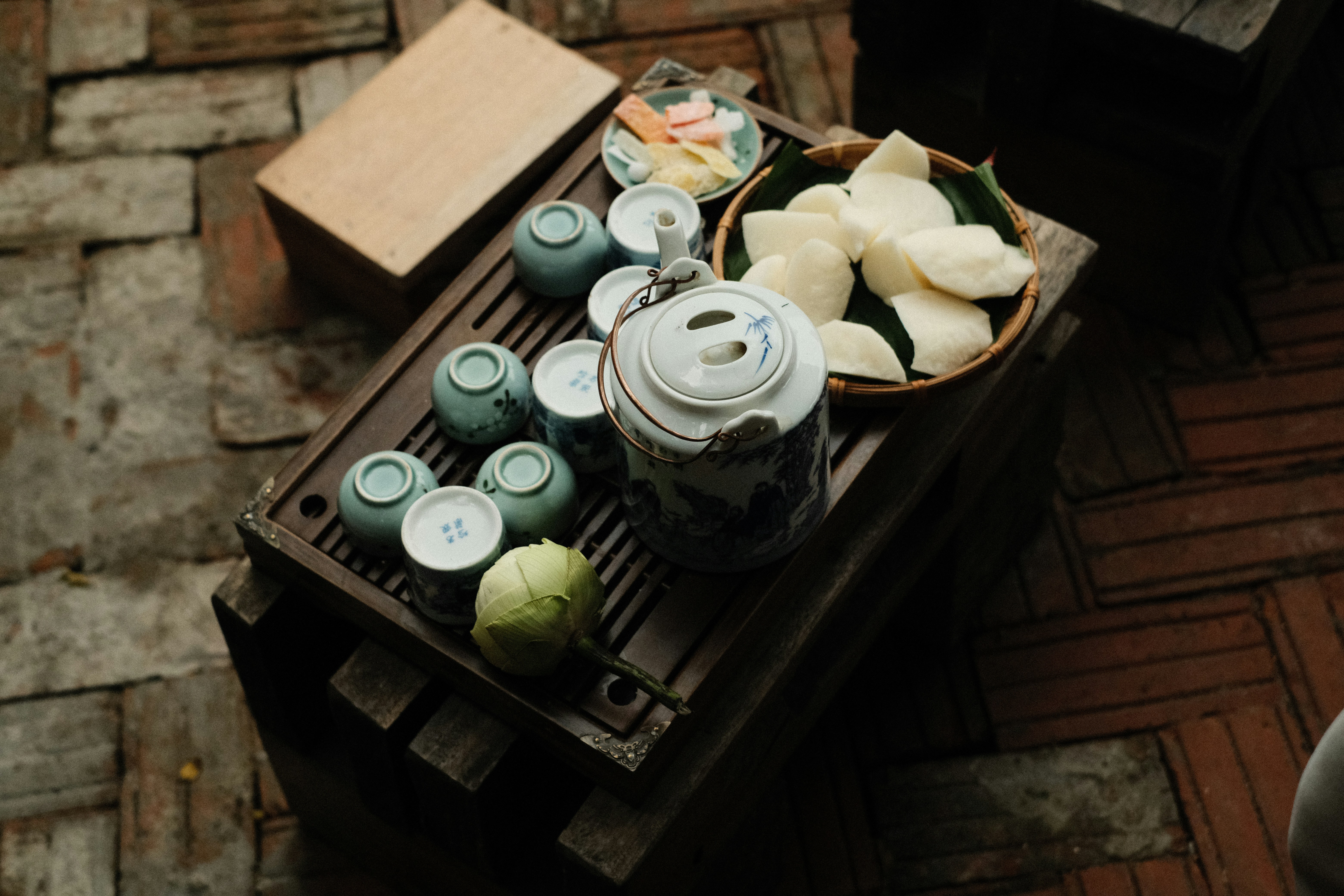 Tea Tray at Dusk: Creamer, Cheeses, and Citrus on a Wooden Table