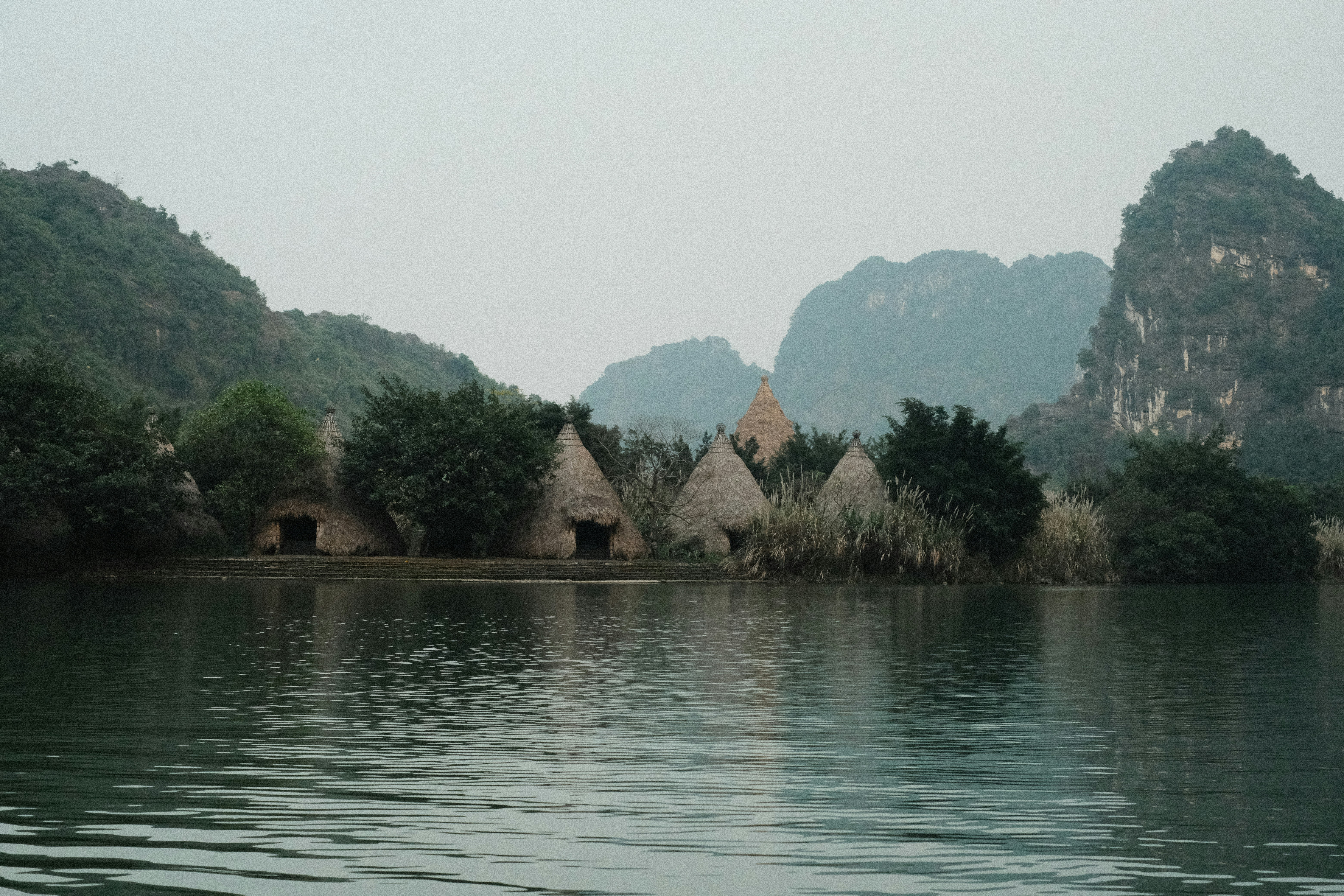 Water’s Edge: Village Huts Nestled at the Lake’s Quiet Border