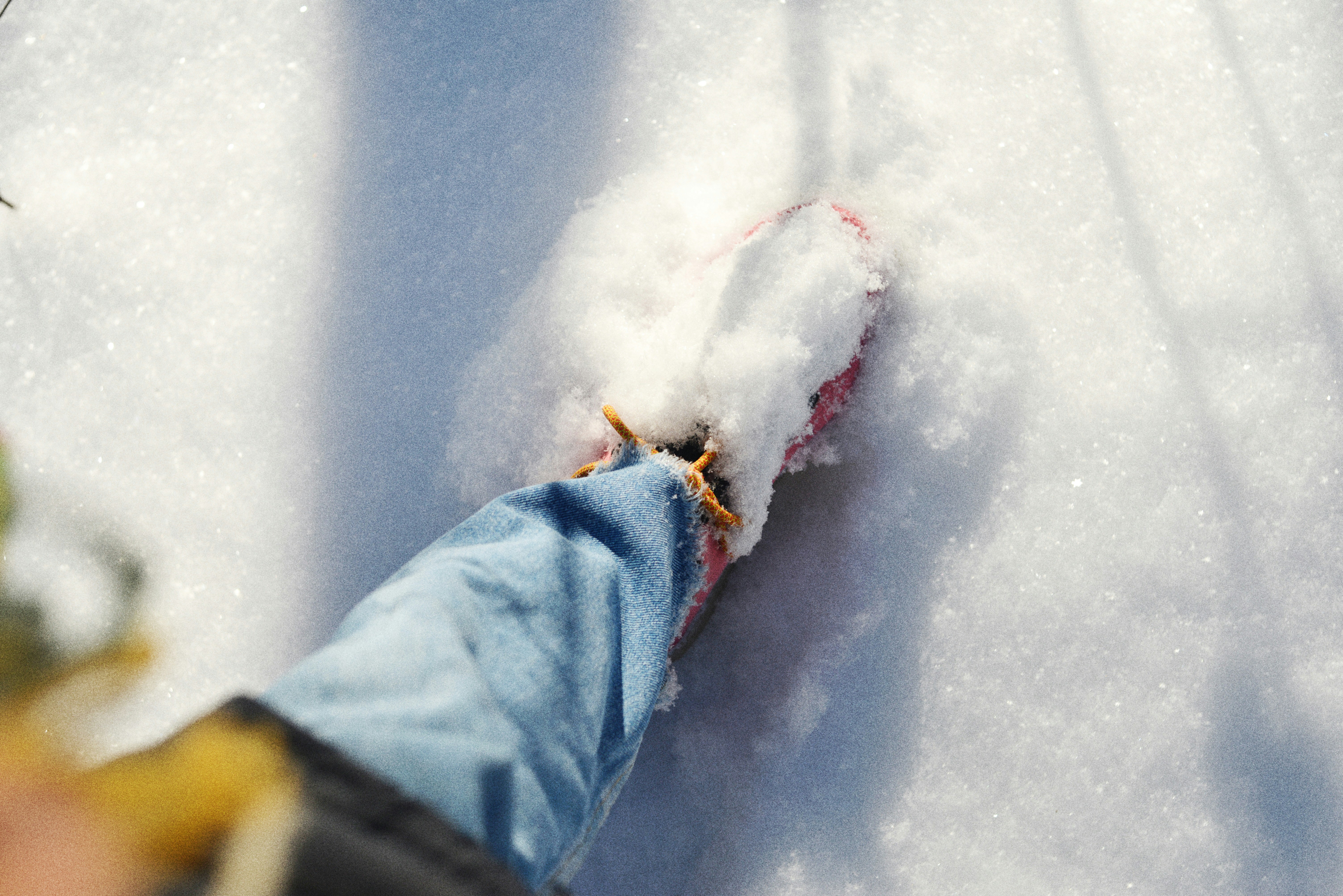Snowbound Path: A Gloved Foot Trek Across Fresh Powder