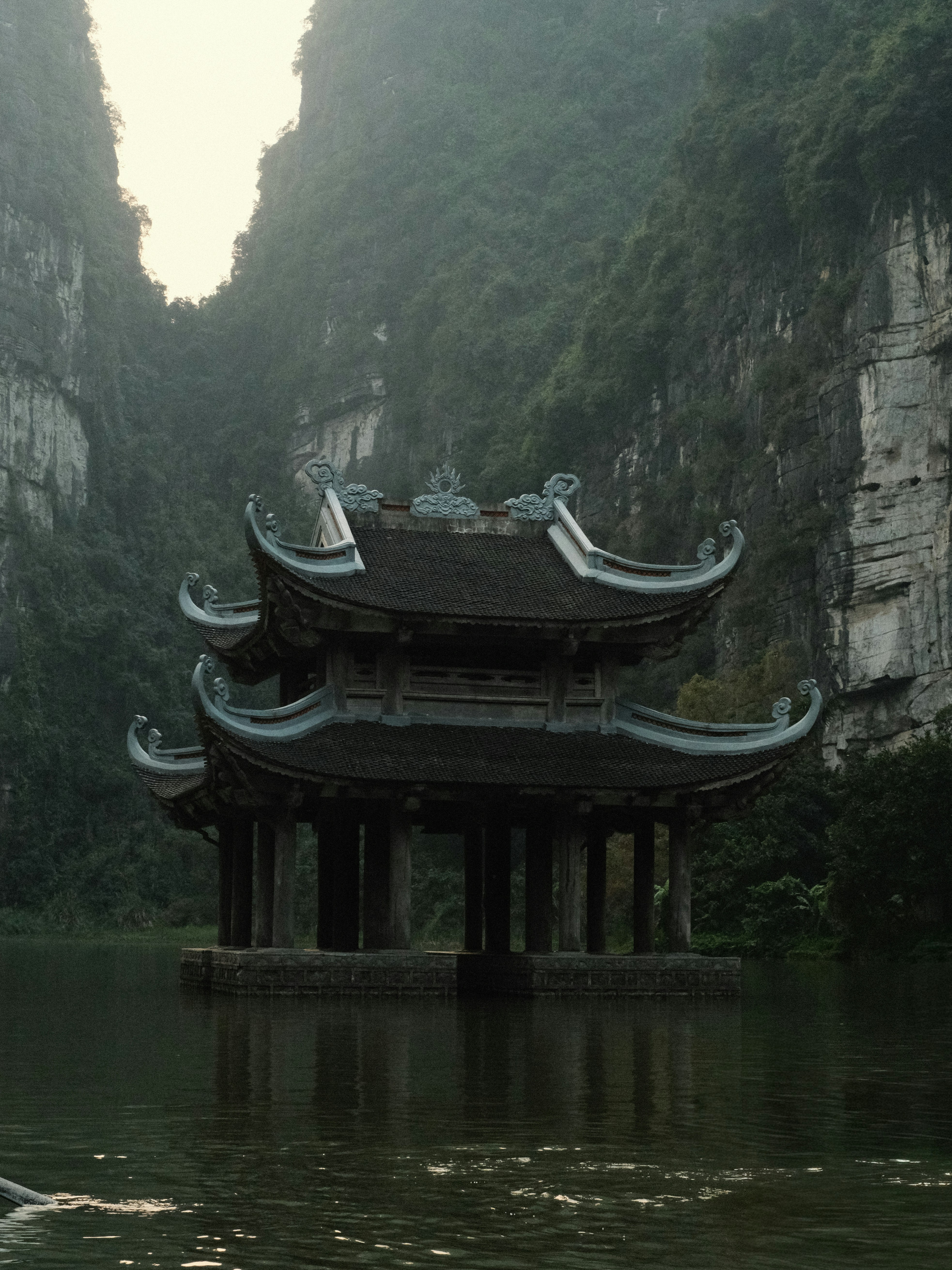 Stone-Pierred Pagoda on a Quiet Lake Between towering cliffs