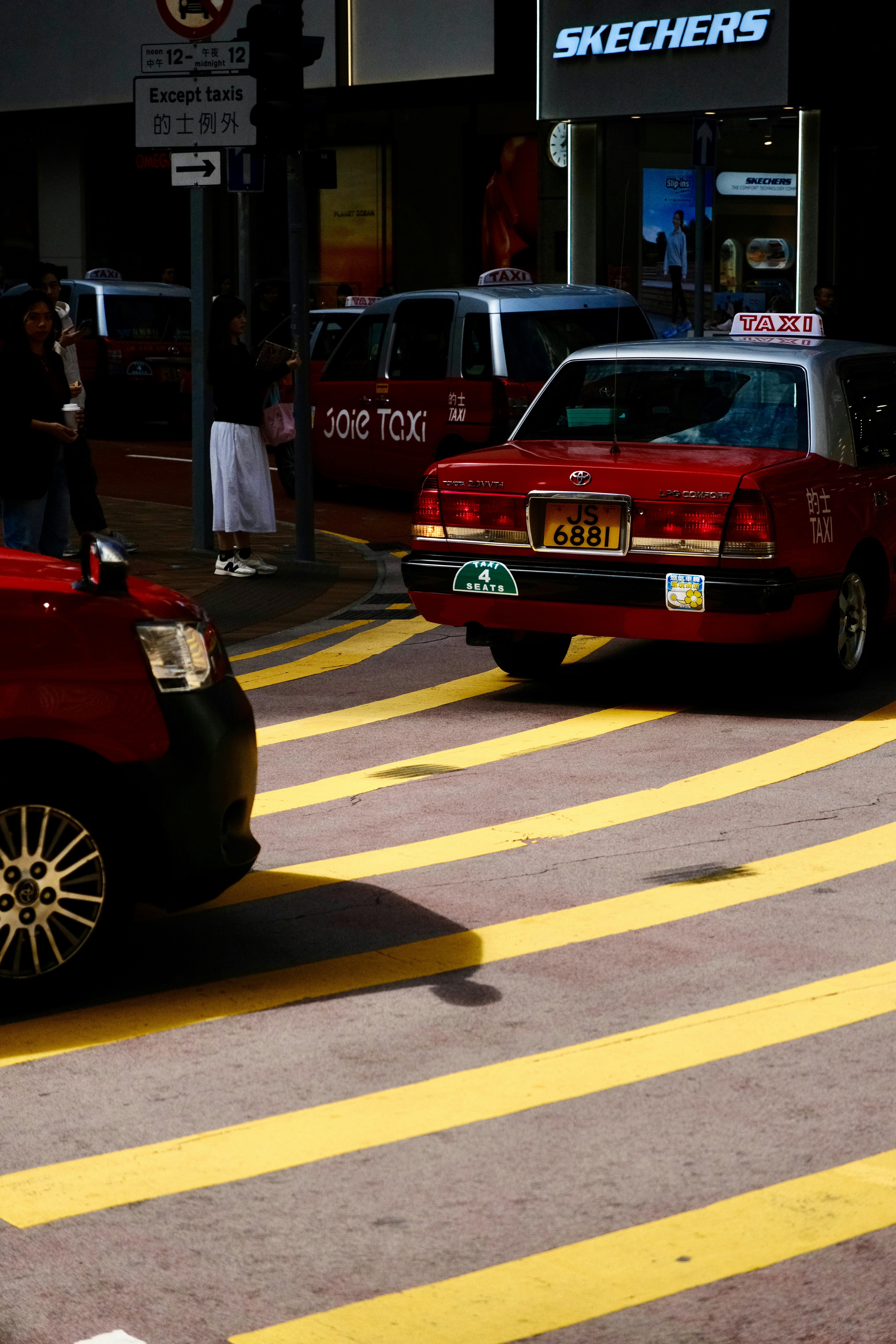 Taxi Standoff at a Sunlit Crosswalk