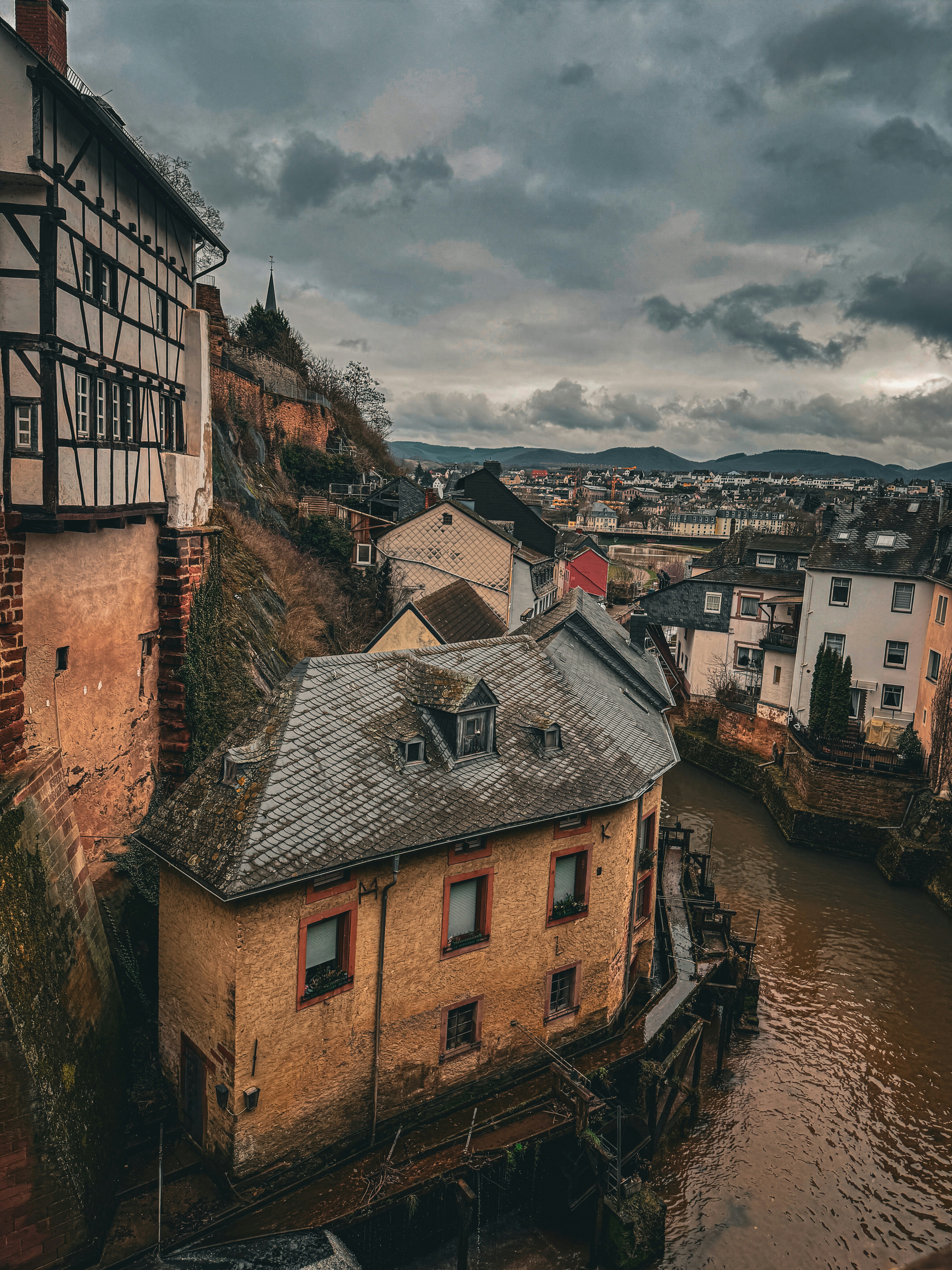 Medieval Riverside Village: Roofs, Water, and the Overcast Sky