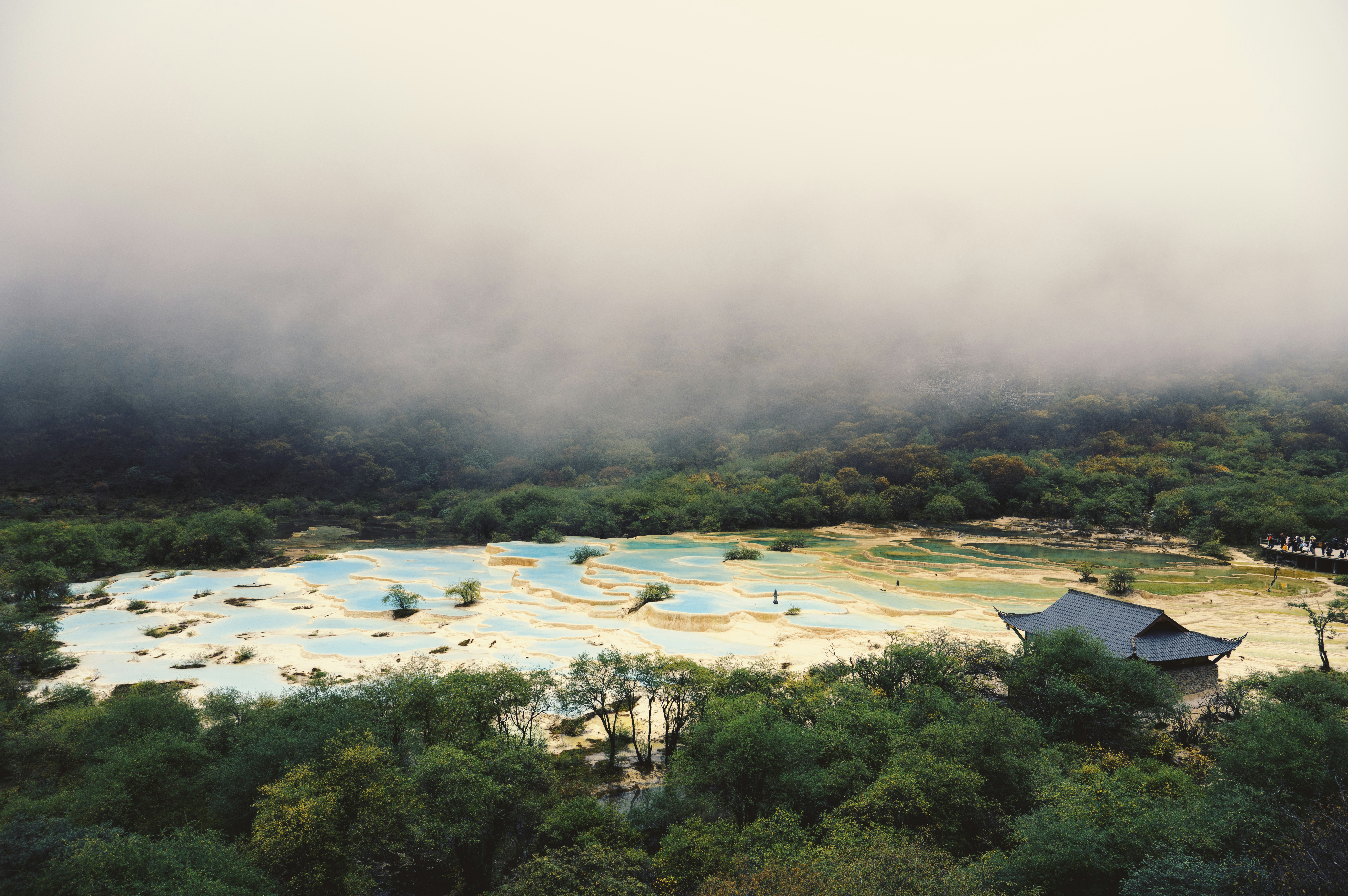 Misty Terraces: Sunrise Over a Serene Karst Landscape