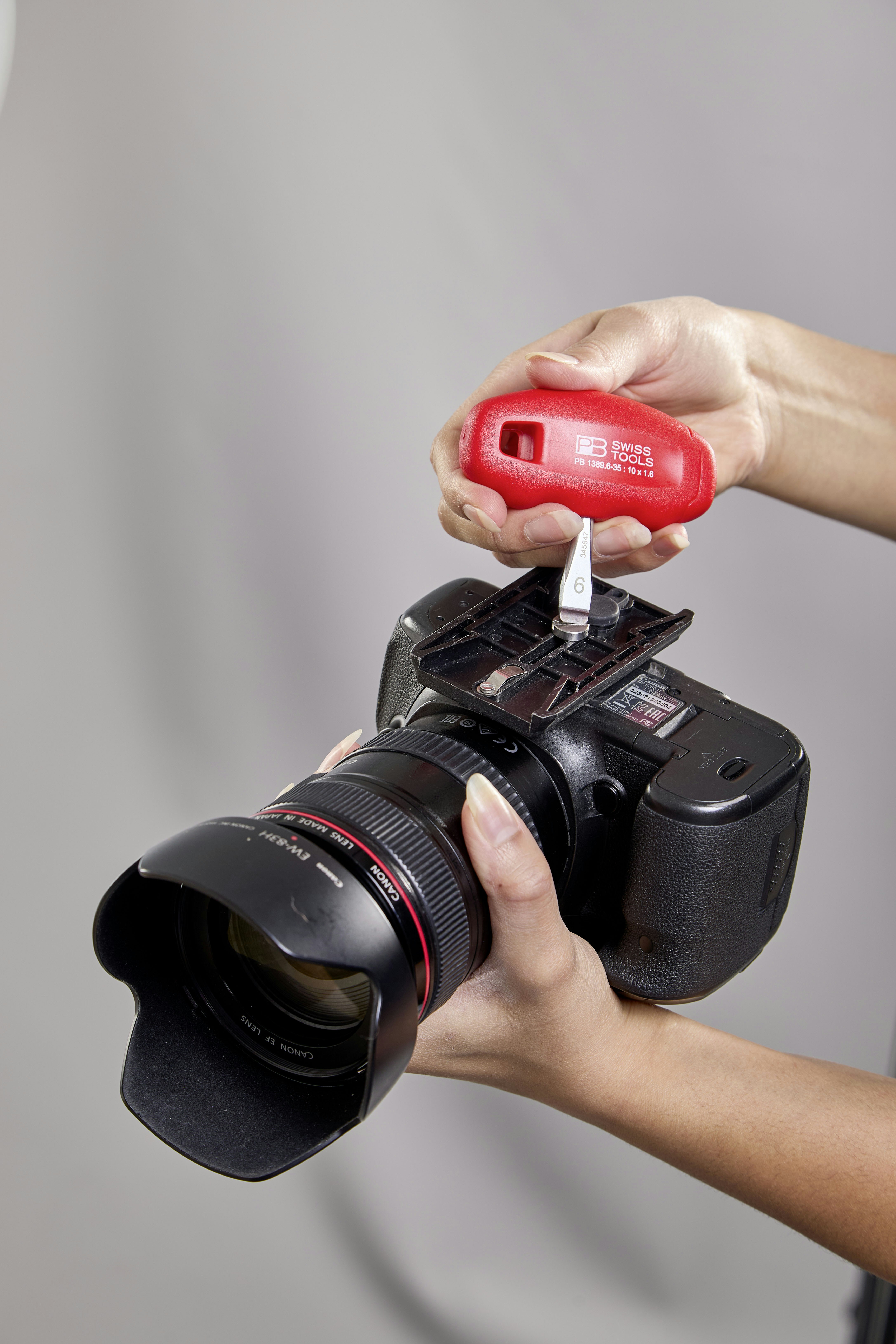 Tethered Precision: A Handful of Gear and a Red Tool
