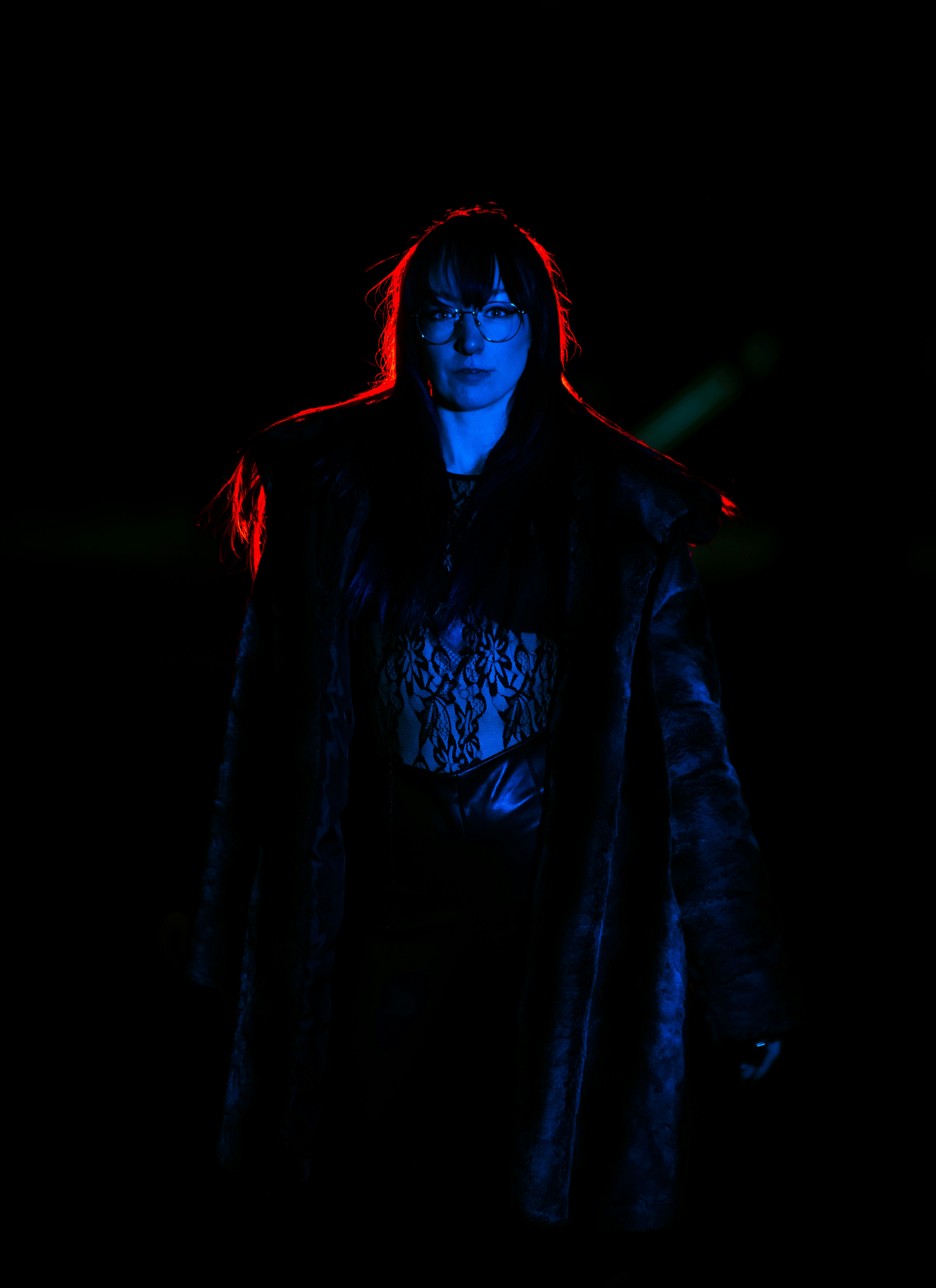 Blue Glow: Portrait Under Neon-Red Edge Lighting