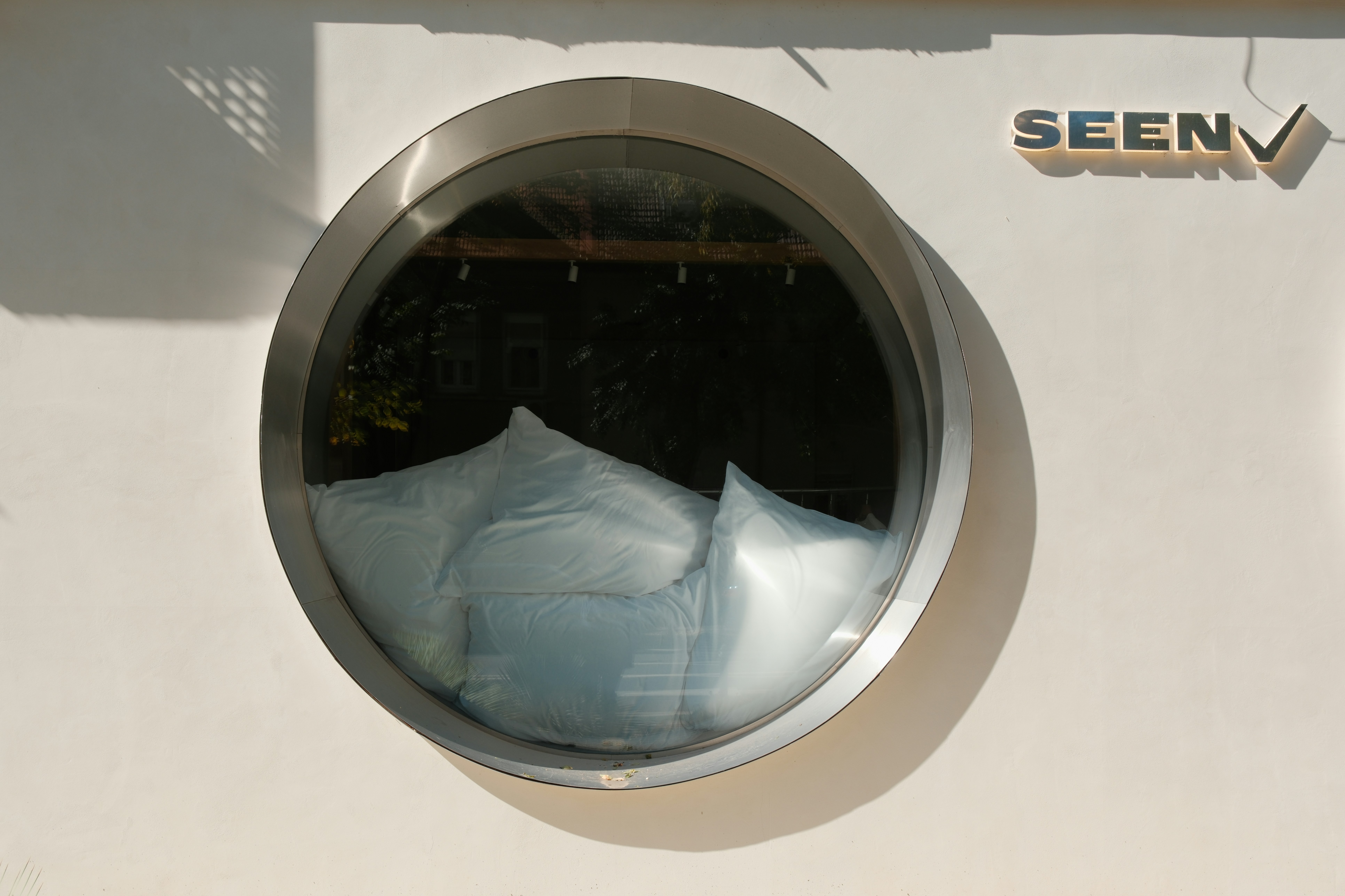 Circular Window, Soft Cushions: Quiet Harbor of Light