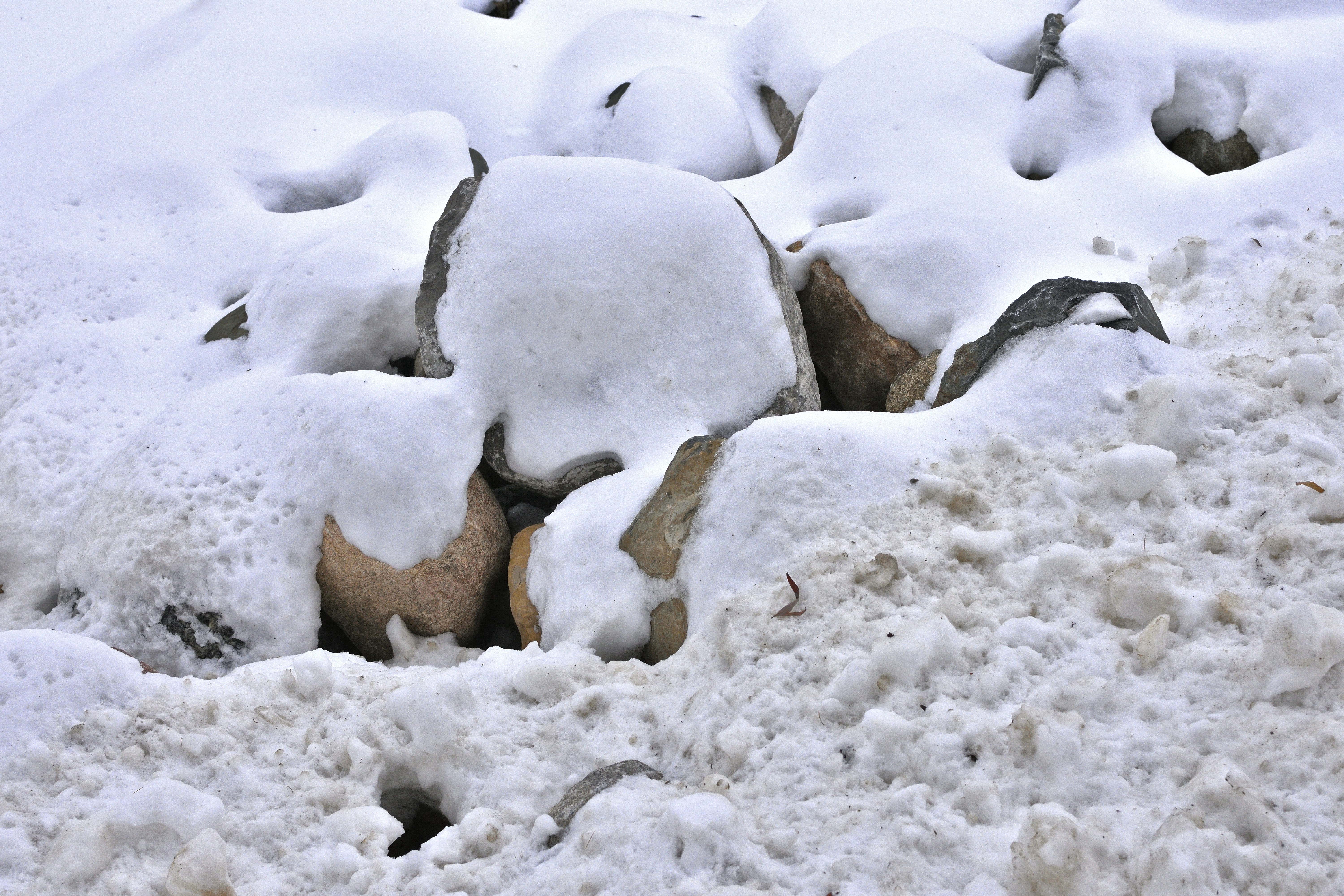 Snow-covered Stones: Soft Texture and Subtle Shadow Play