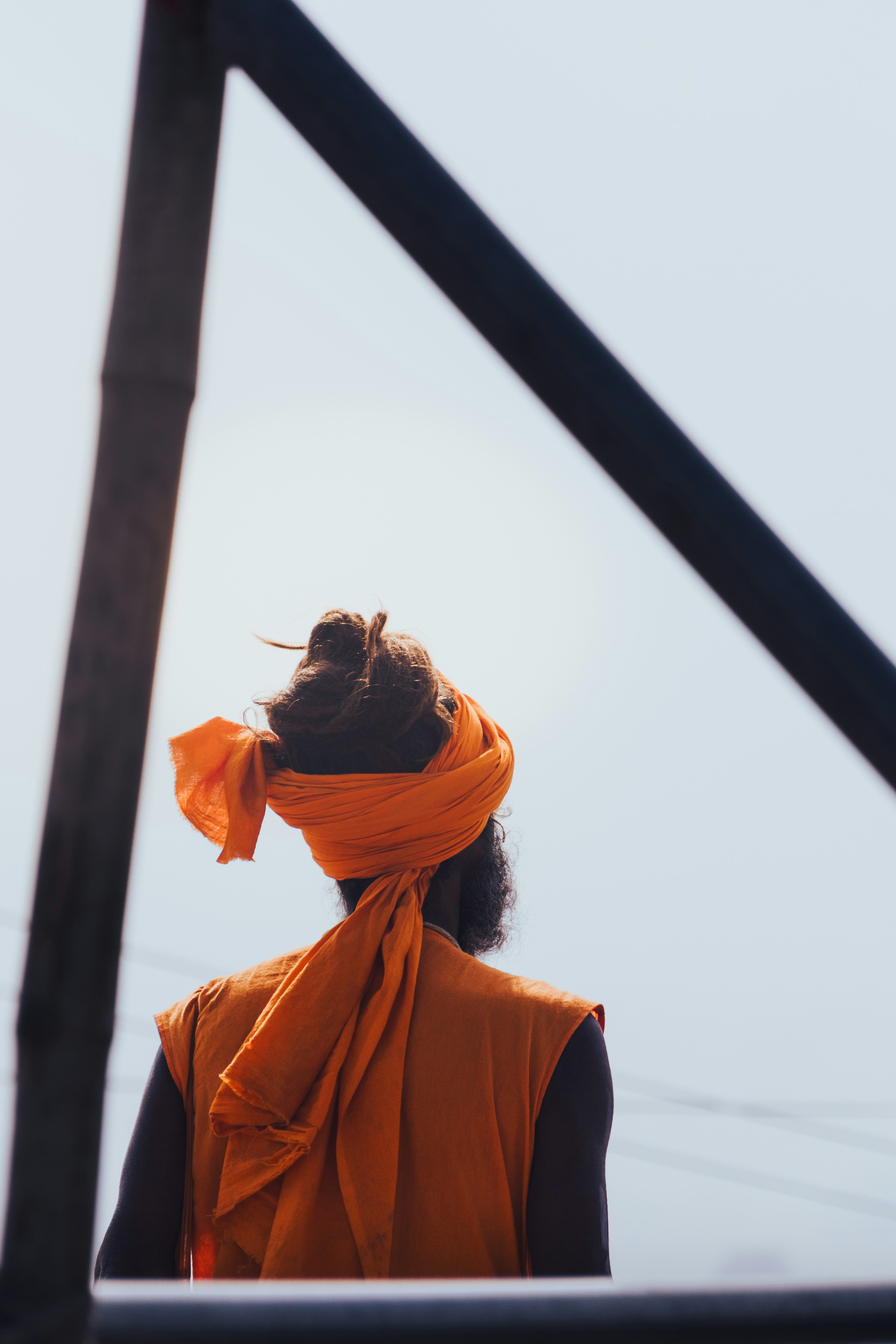 Orange Wrappings: A Silent Portrait in Sunlit Stillness