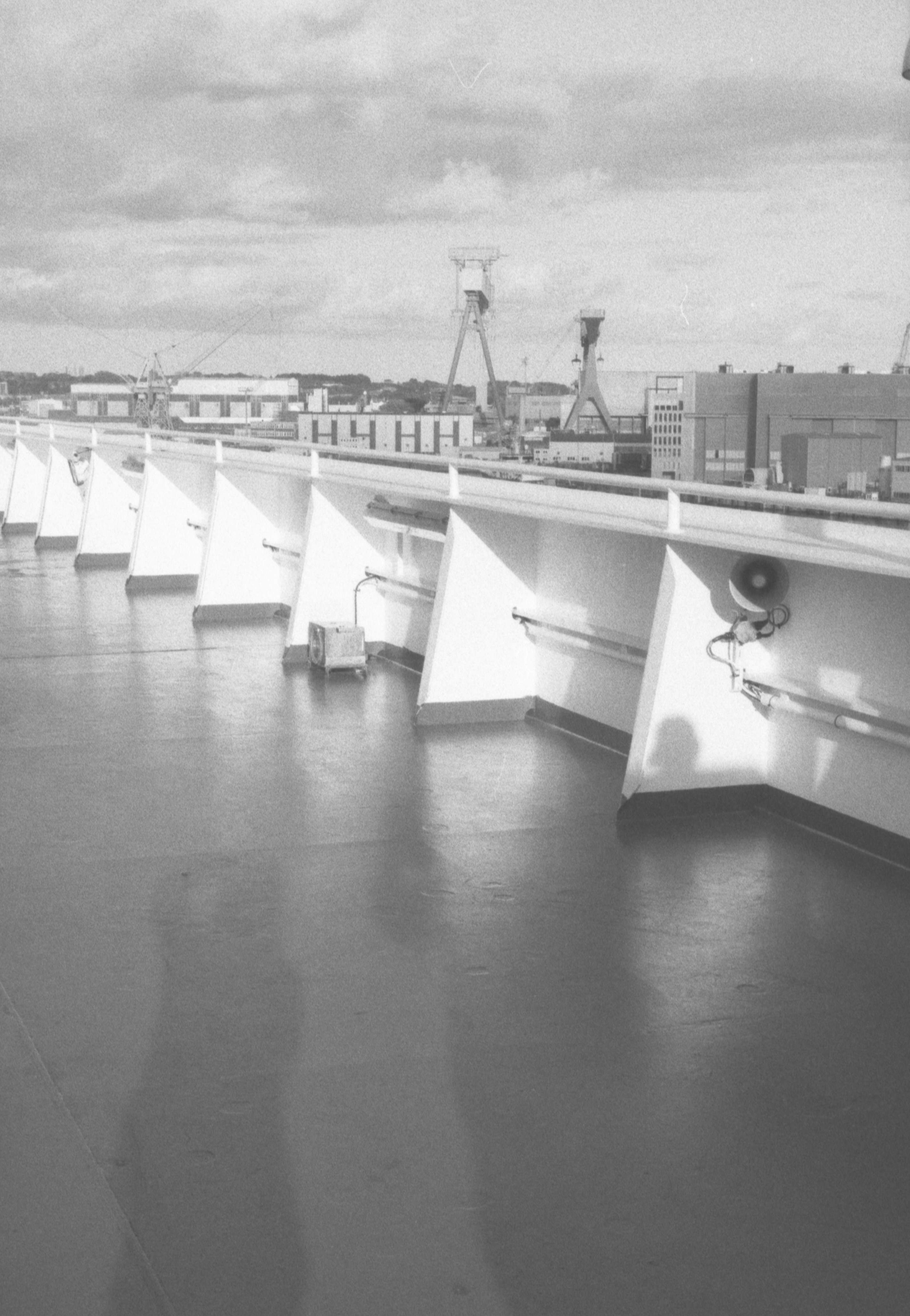 Ship deck with repeating triangular structures and rectangular structures.