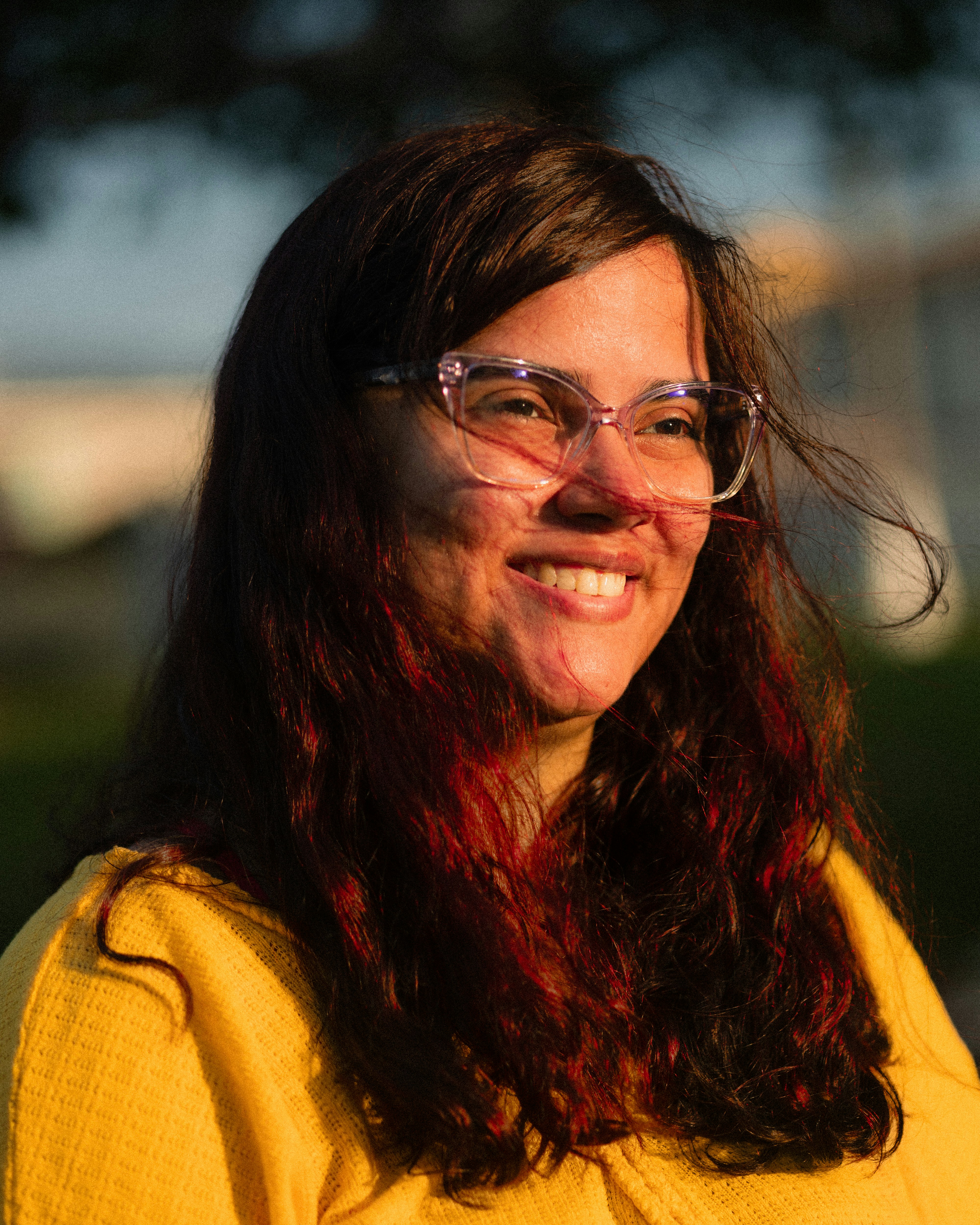 Warm smile, amber light: a portrait in late-day glow