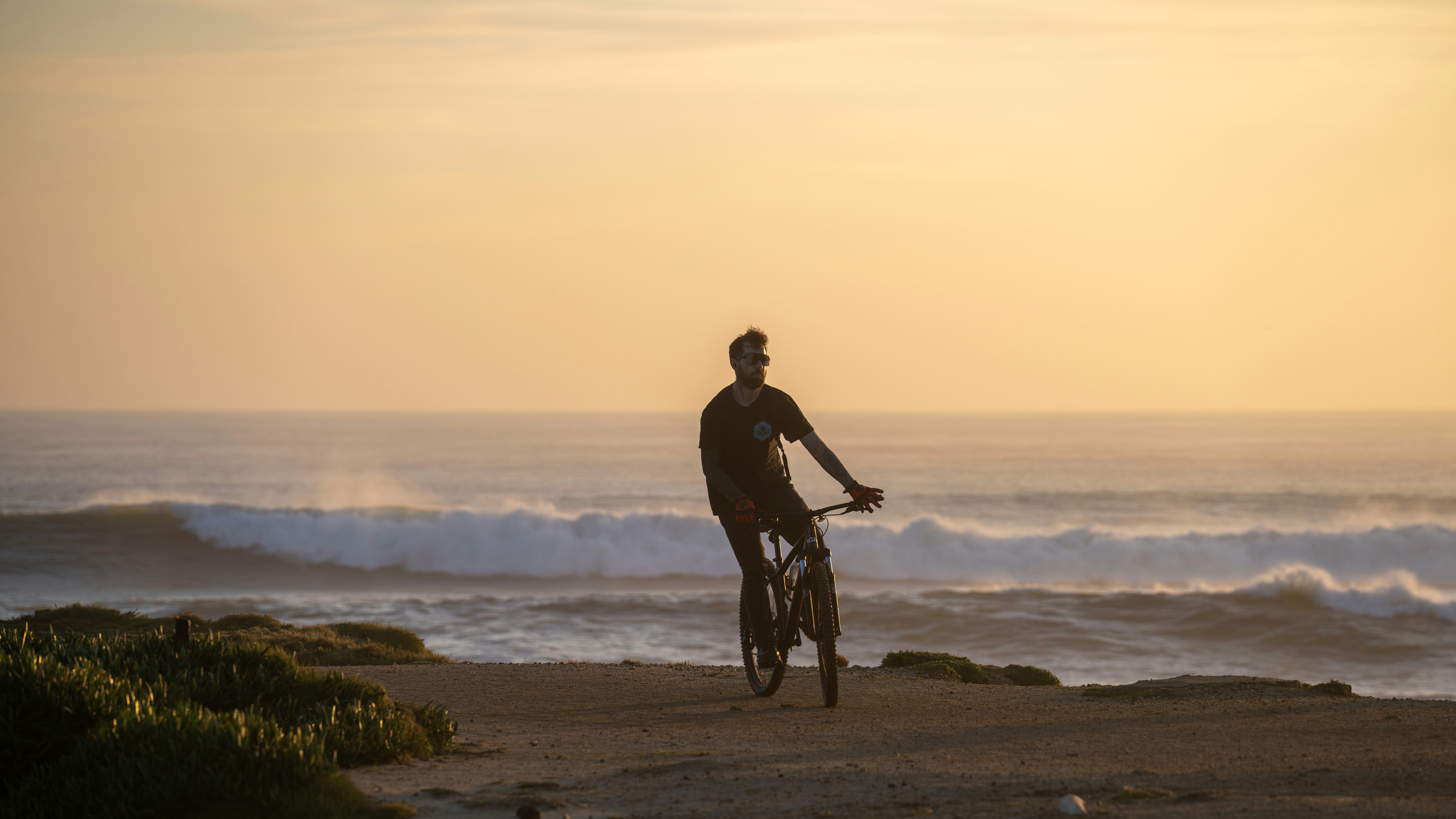 Sunrise Ride: A Lone Cyclist at the Edge of the Tide