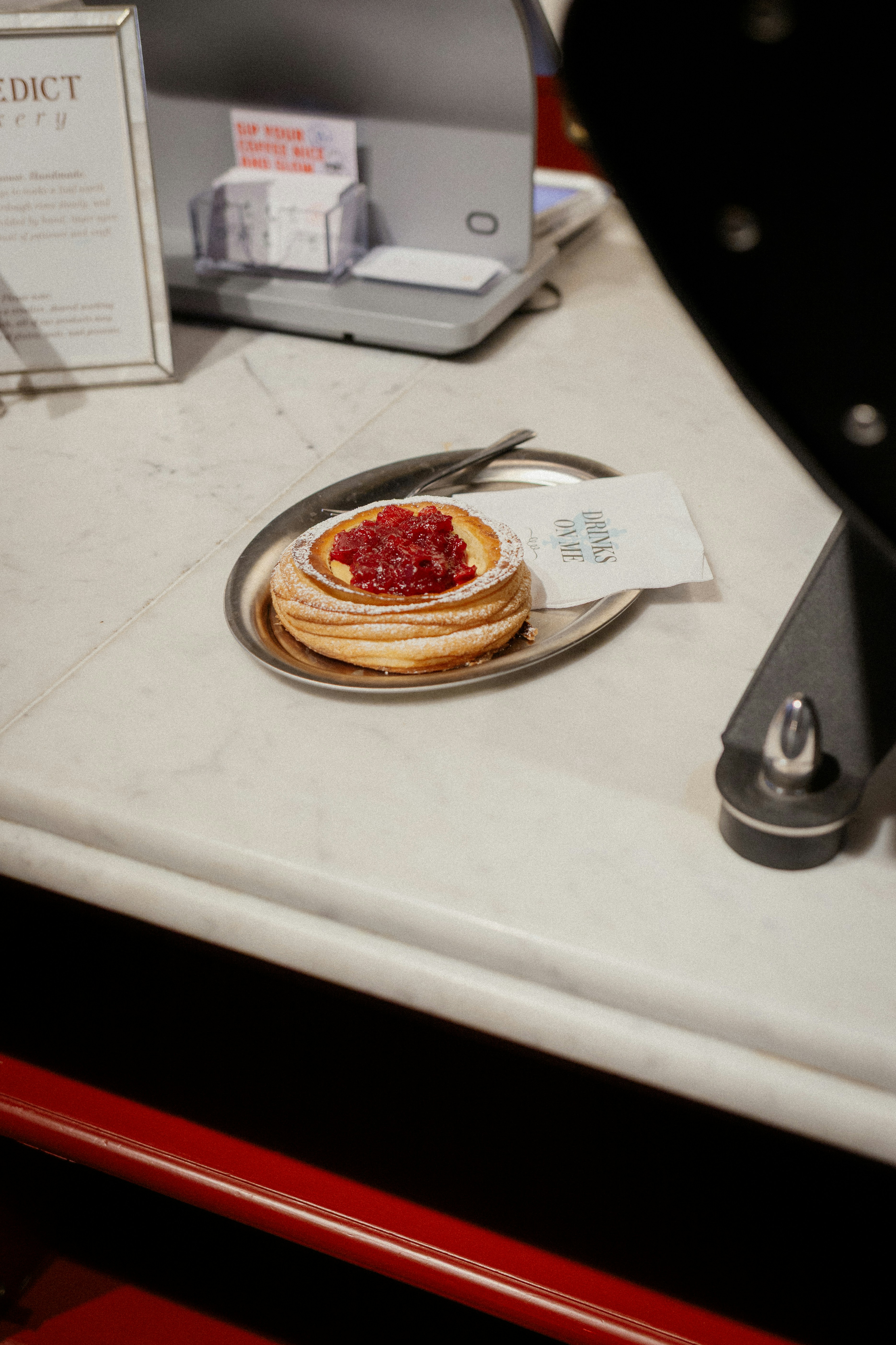 Carousel of Sugar: A Crispy Danish on a Cashier Counter