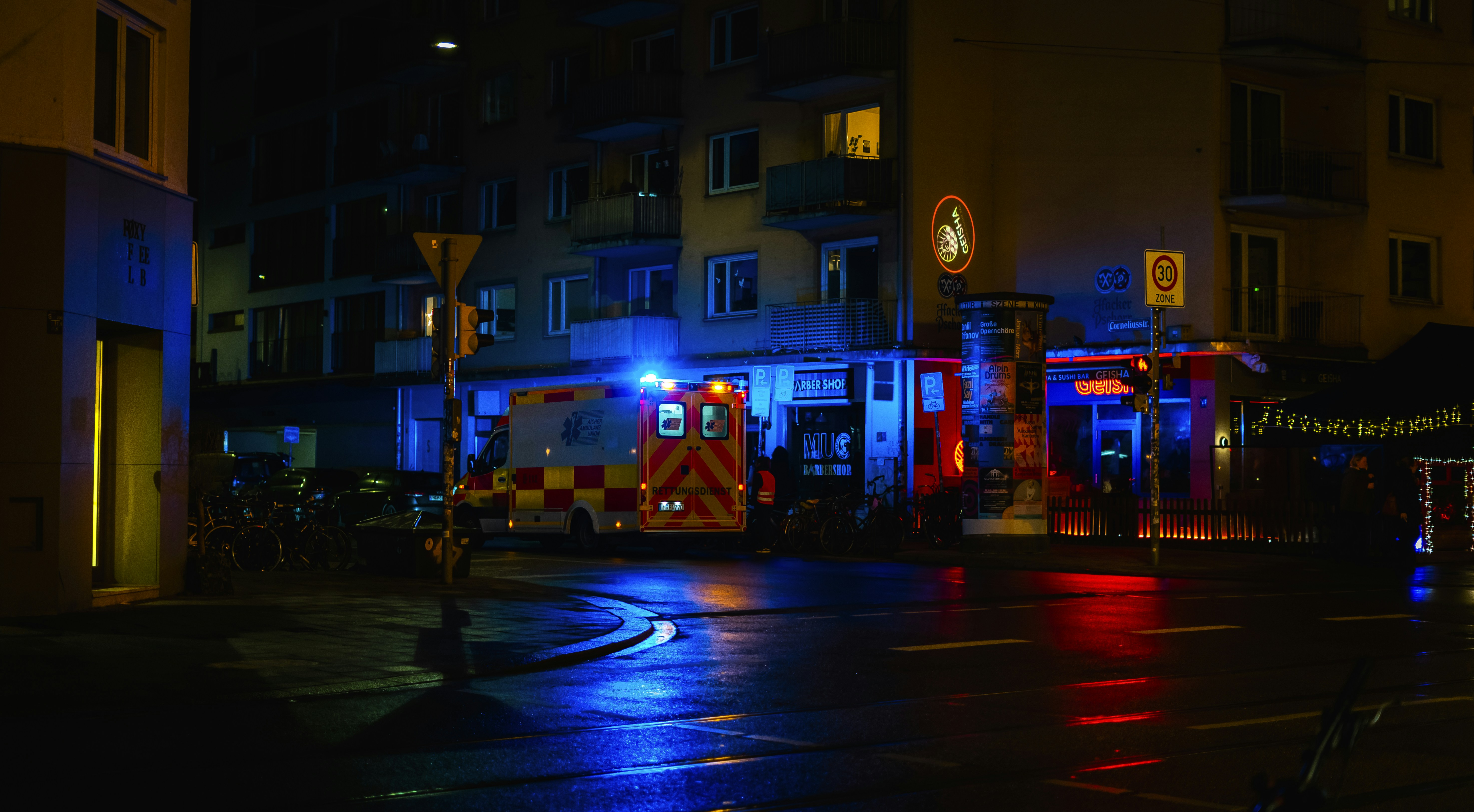 Blue Night Alert: Emergency Lights Reflect on a Wet Street