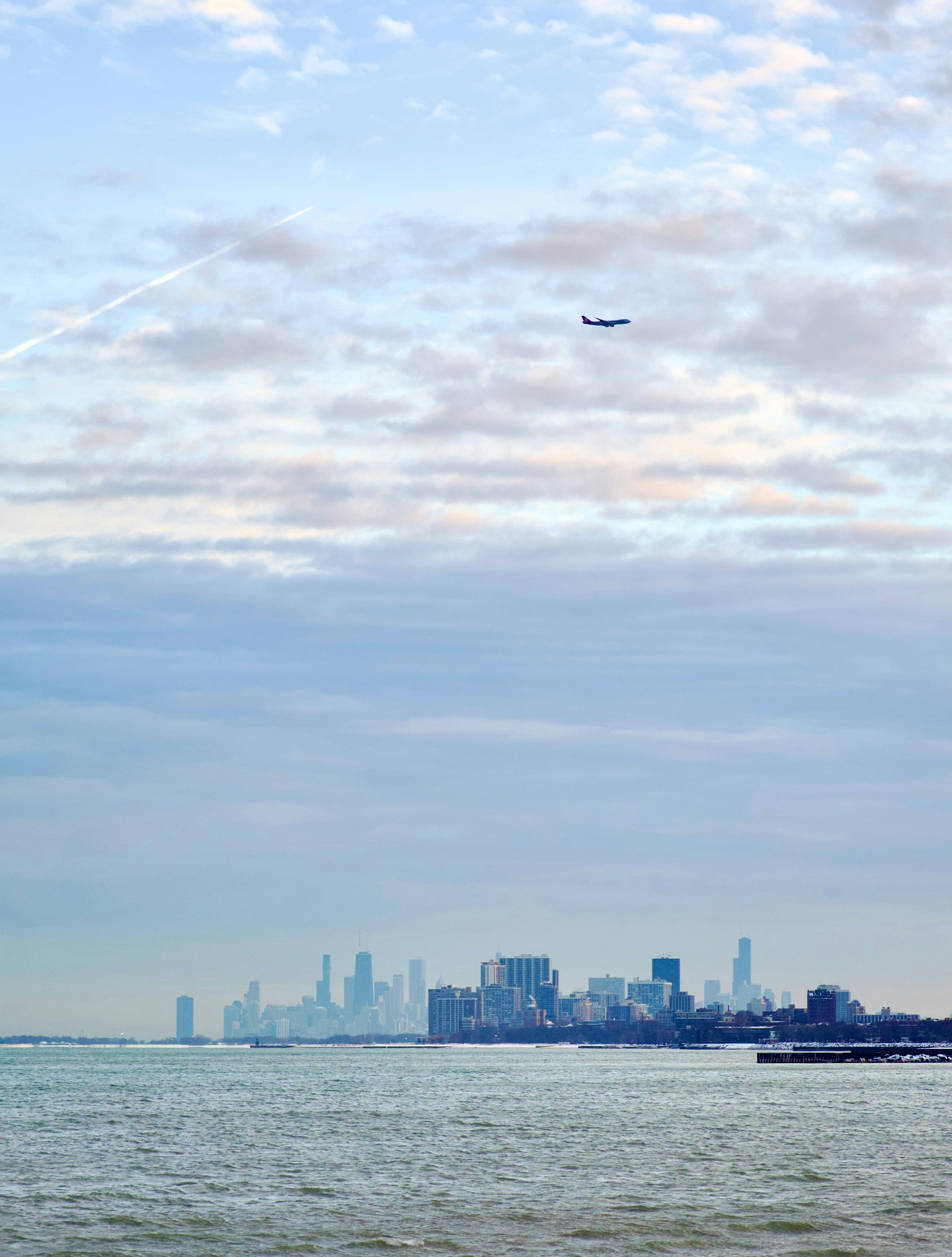 City by the Sea: Horizon Silhouette and a Lone Sky Route