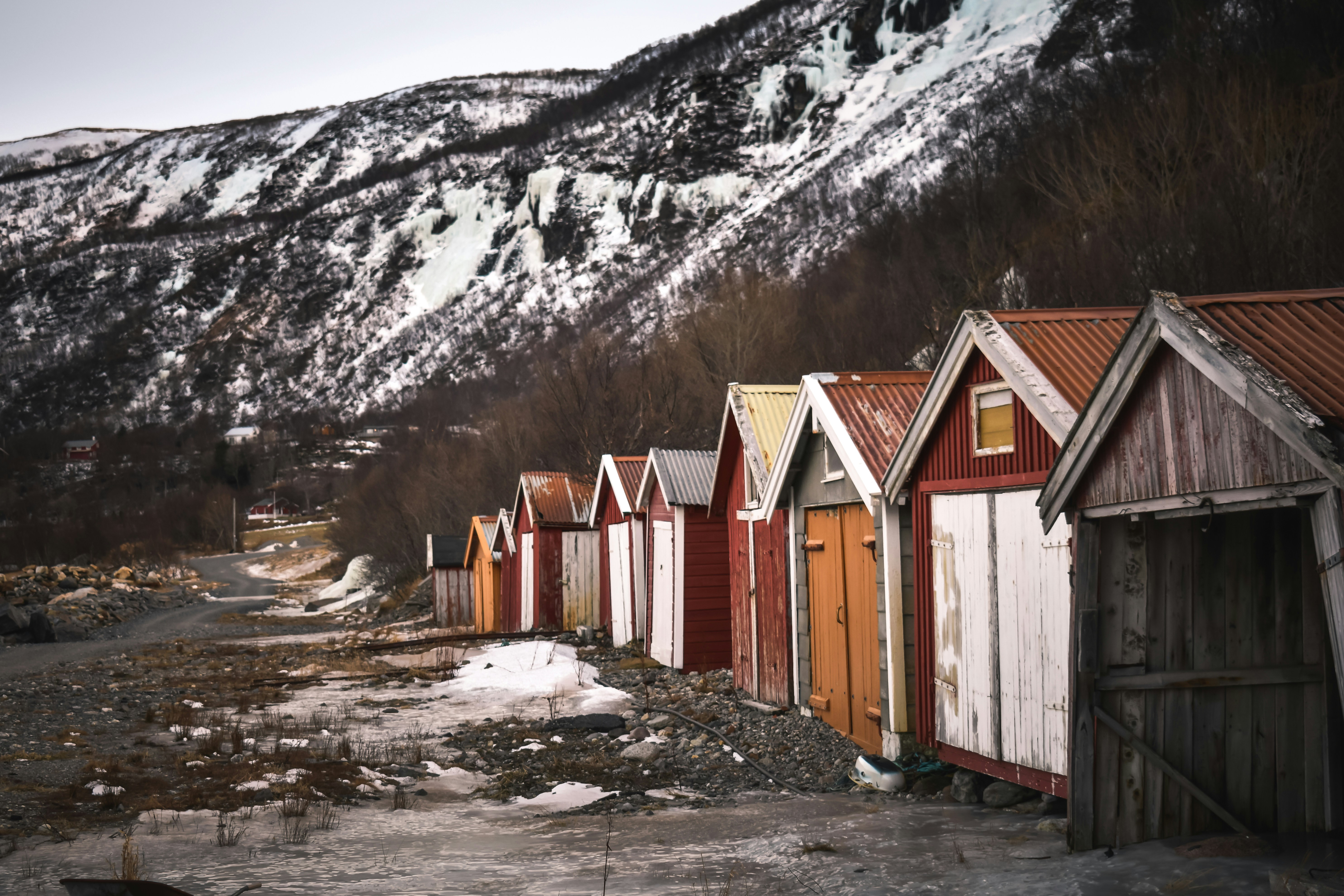 Row of Colorful Boat Sheds Along a Crunching Shoreline