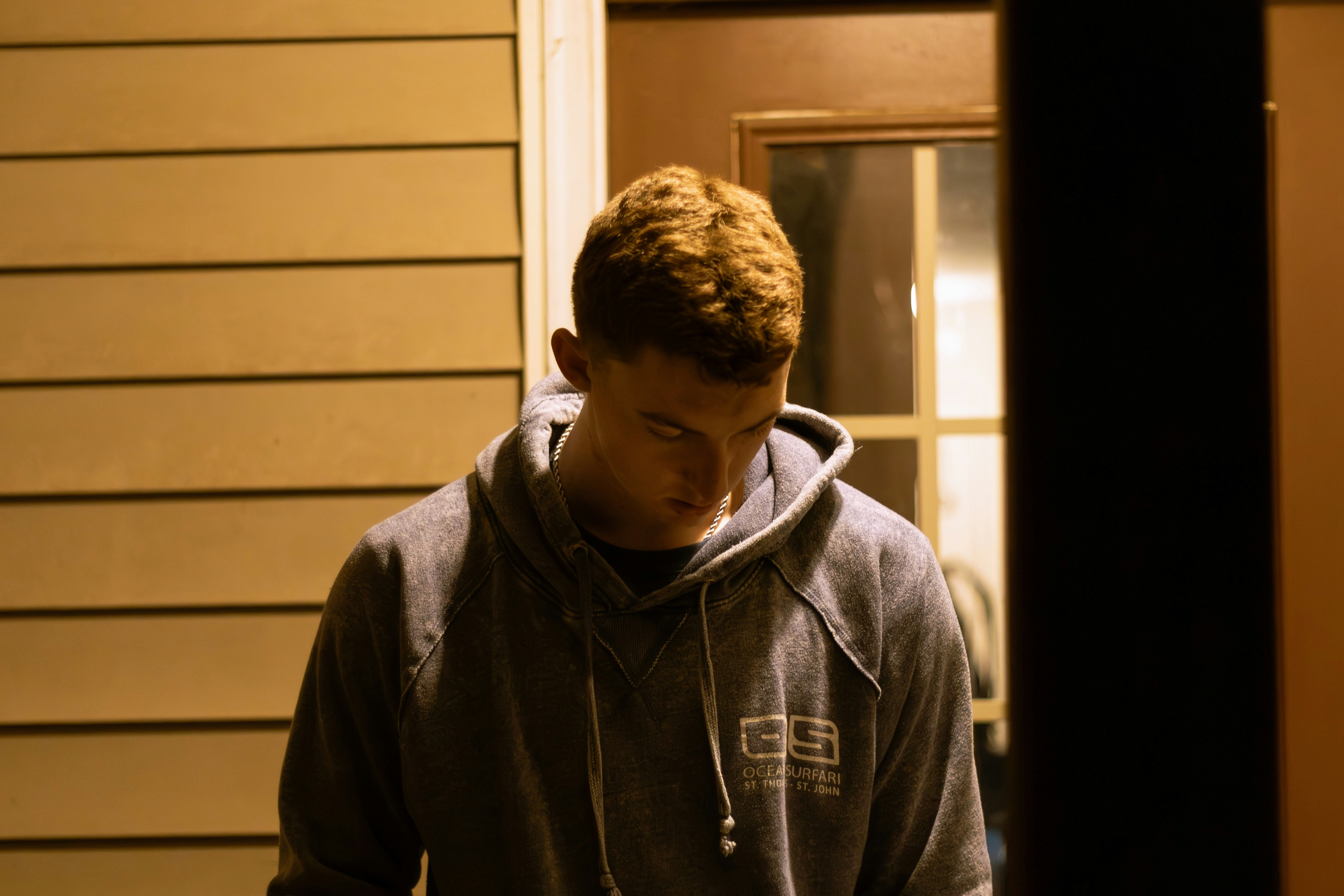 Midnight hoodie silhouette under porch light