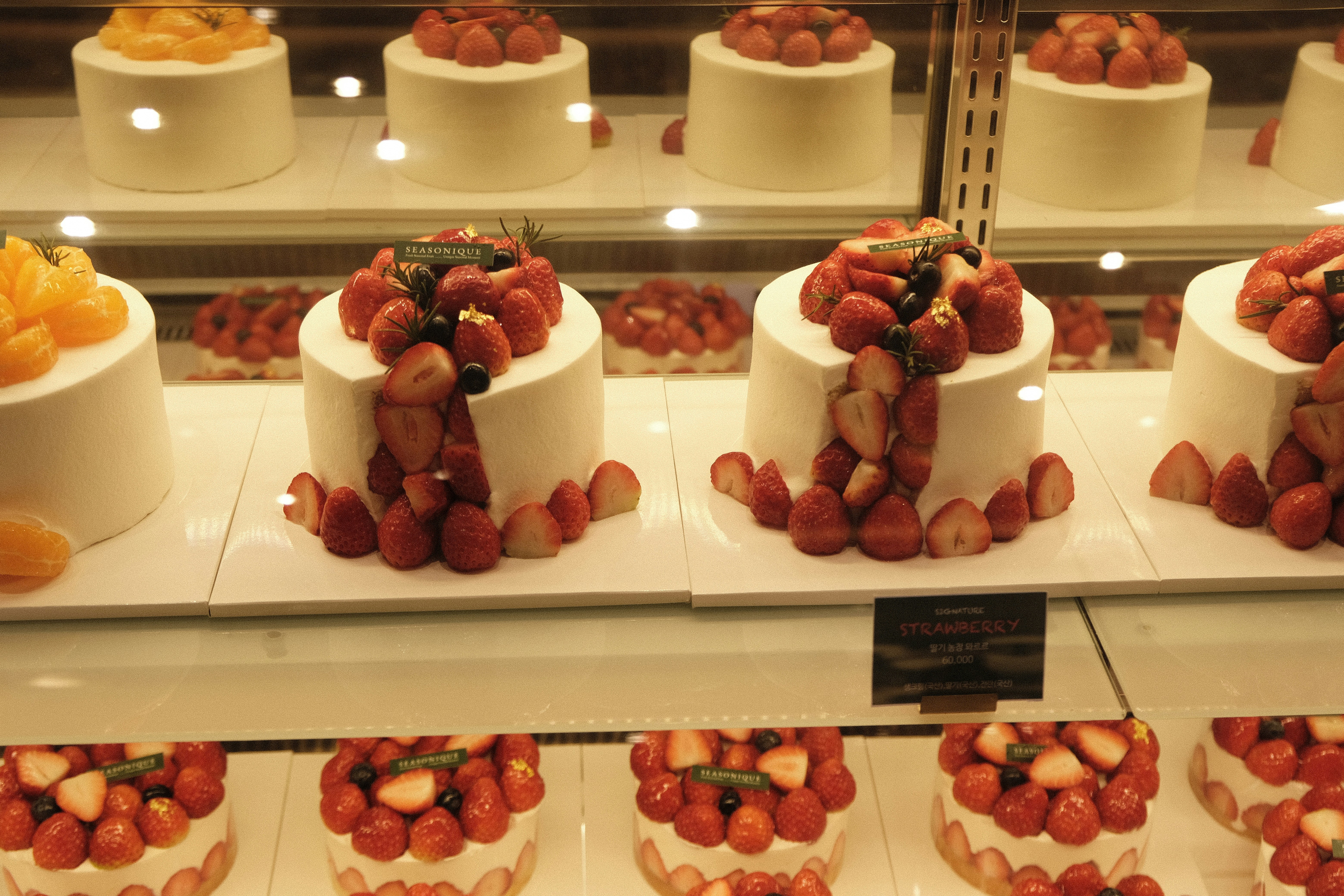 Strawberry-topped Cakes in a Glass-Front Bakery Display