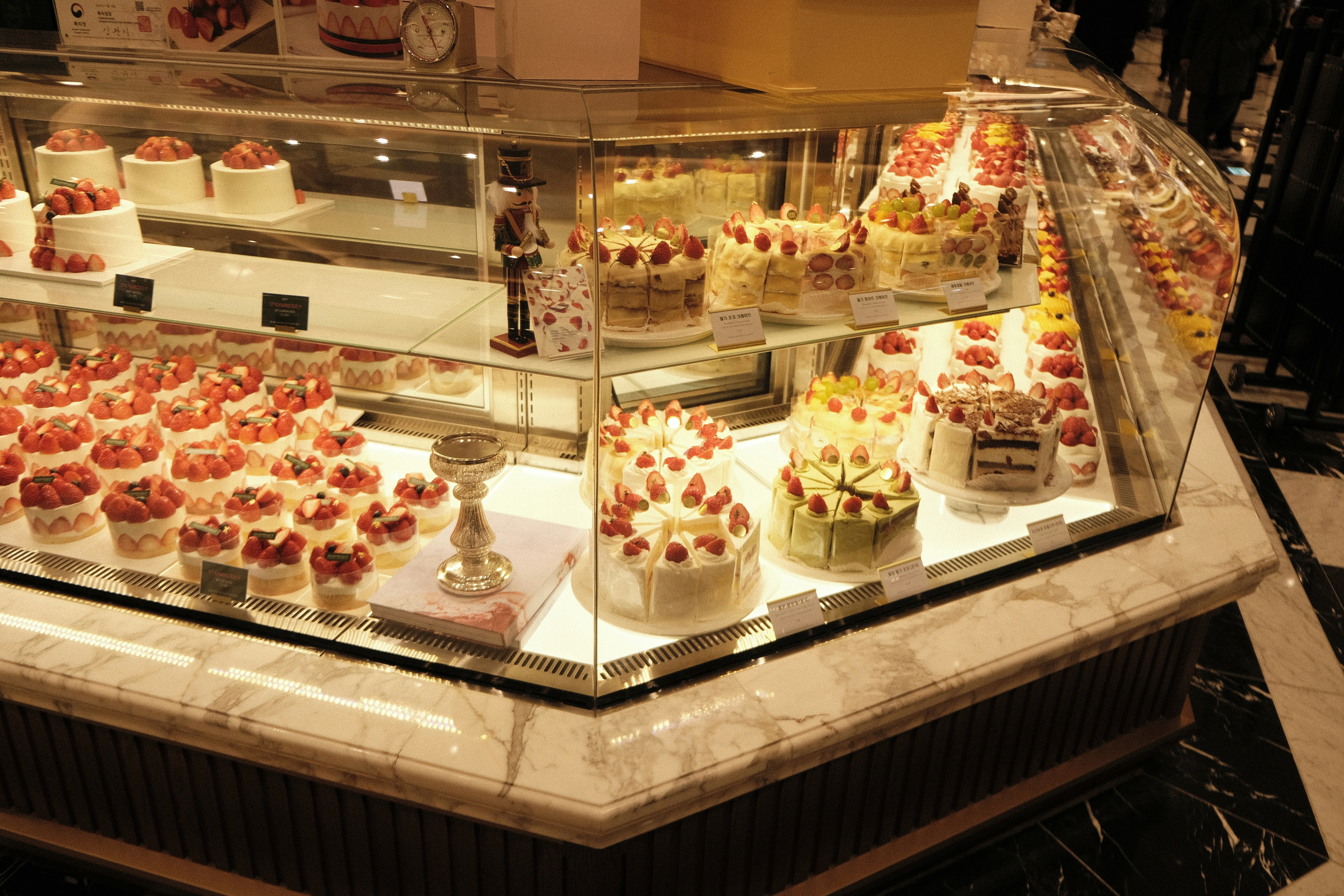 Curated Cakes Under Glass: A Candy‑Colored Display of Petite Pleasures