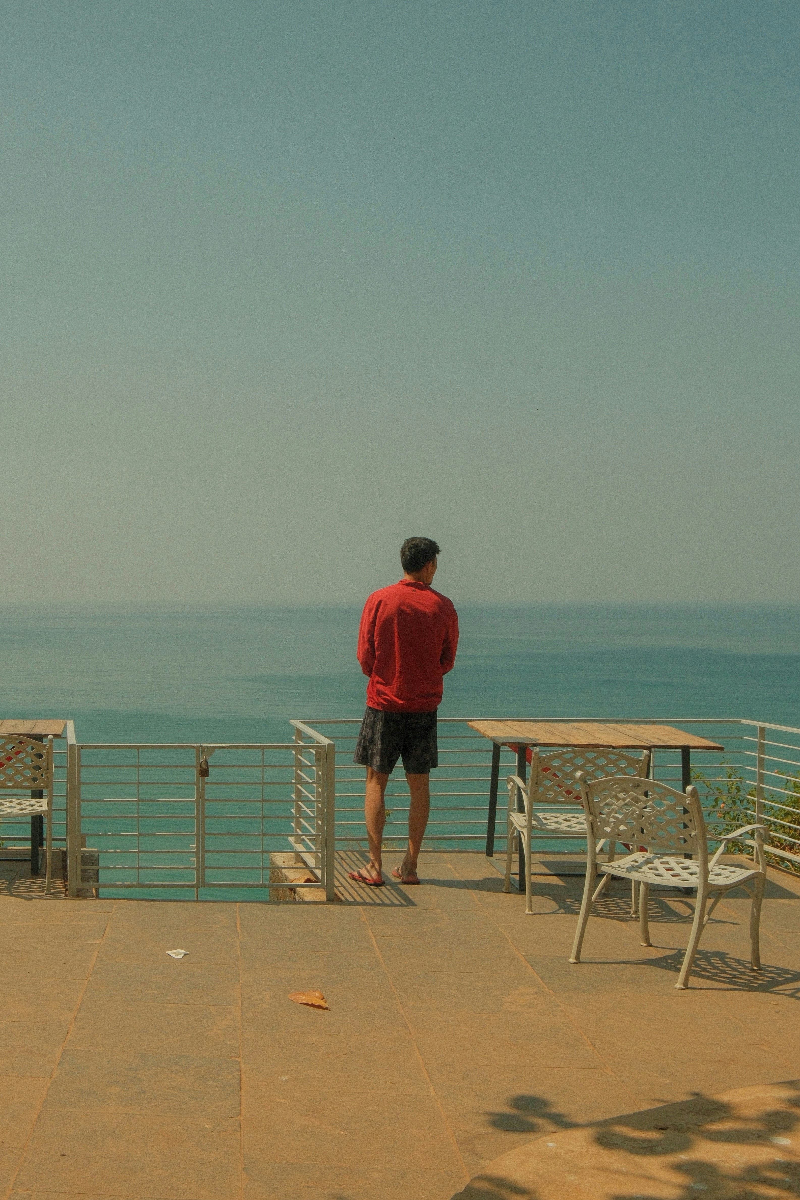 Red-Sweater Solitude at the Sea Edge