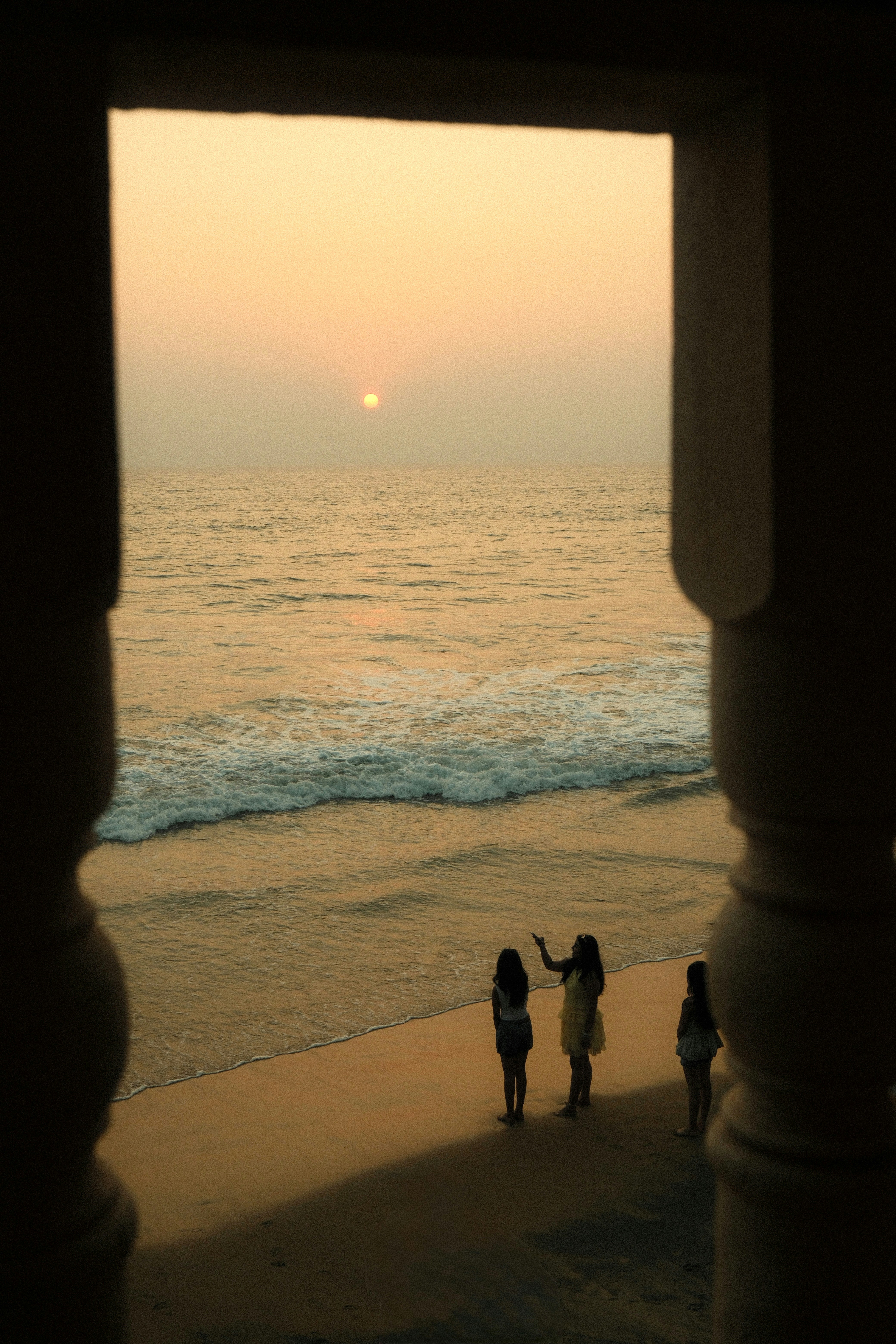 Sunset Dialogue at the Shore Through a Pier Channel
