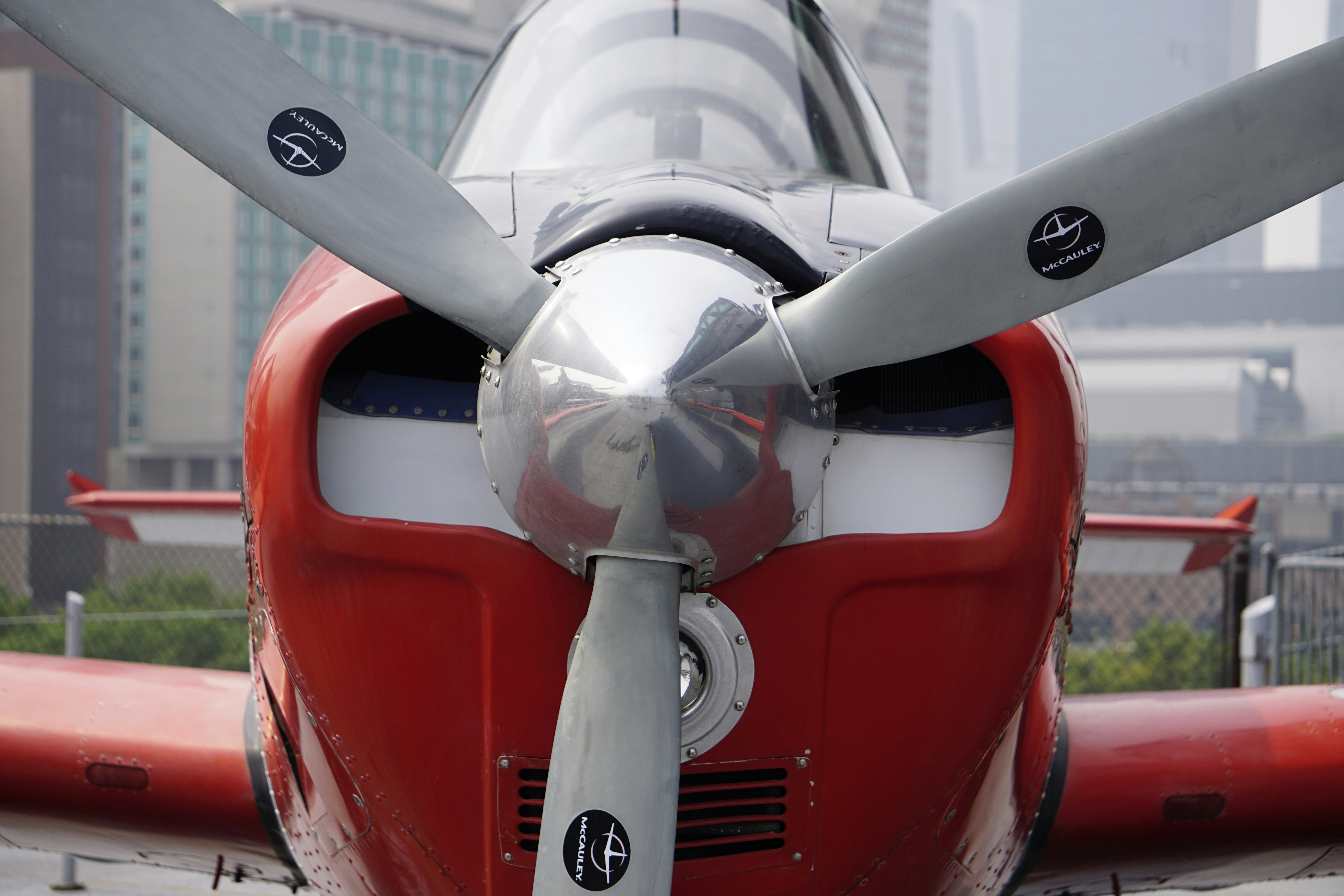 Close-up of a Red Propeller Aircraft Nose with Shiny Spinner