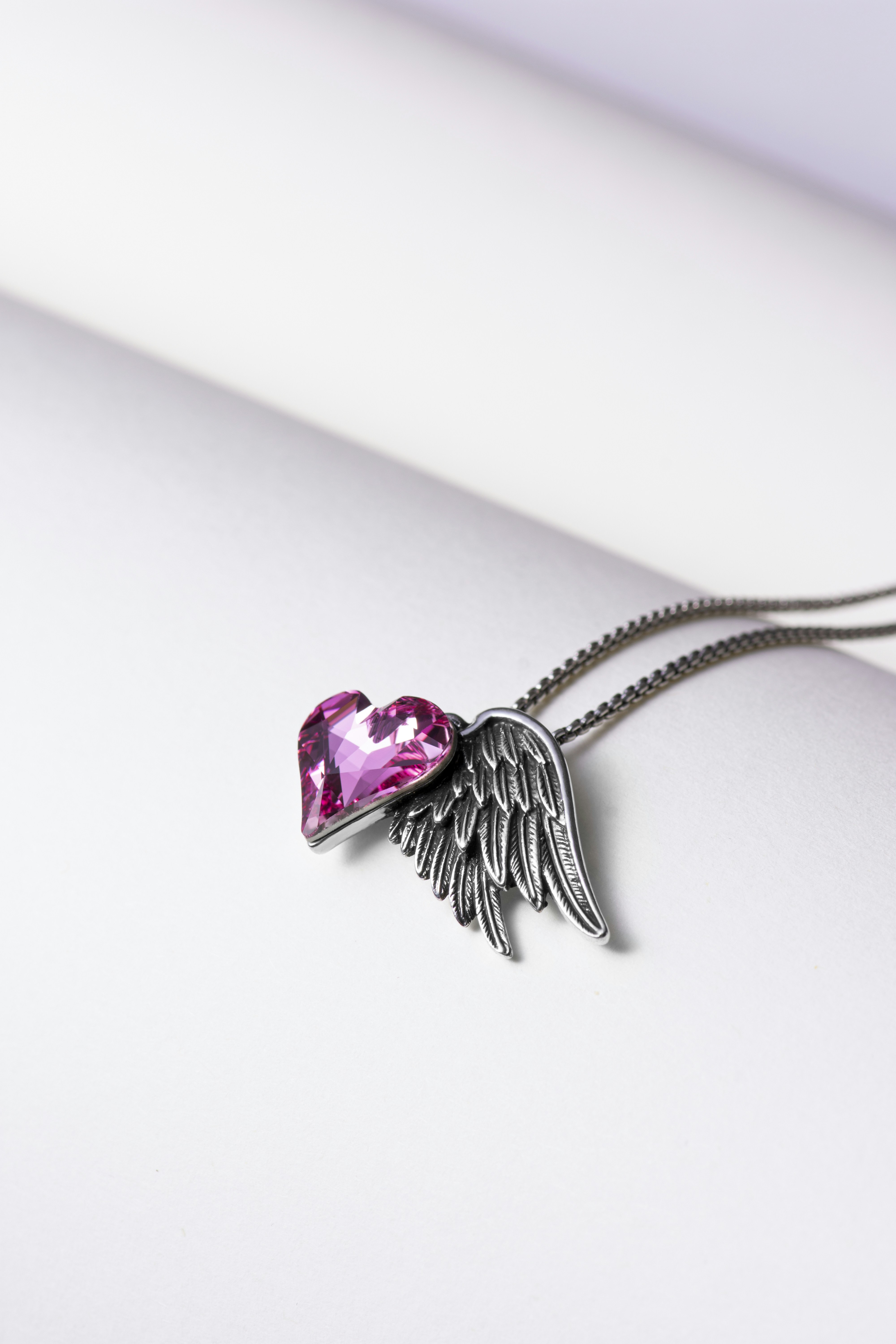 Heart of Metal: A Pink Gem Resting on Silken White